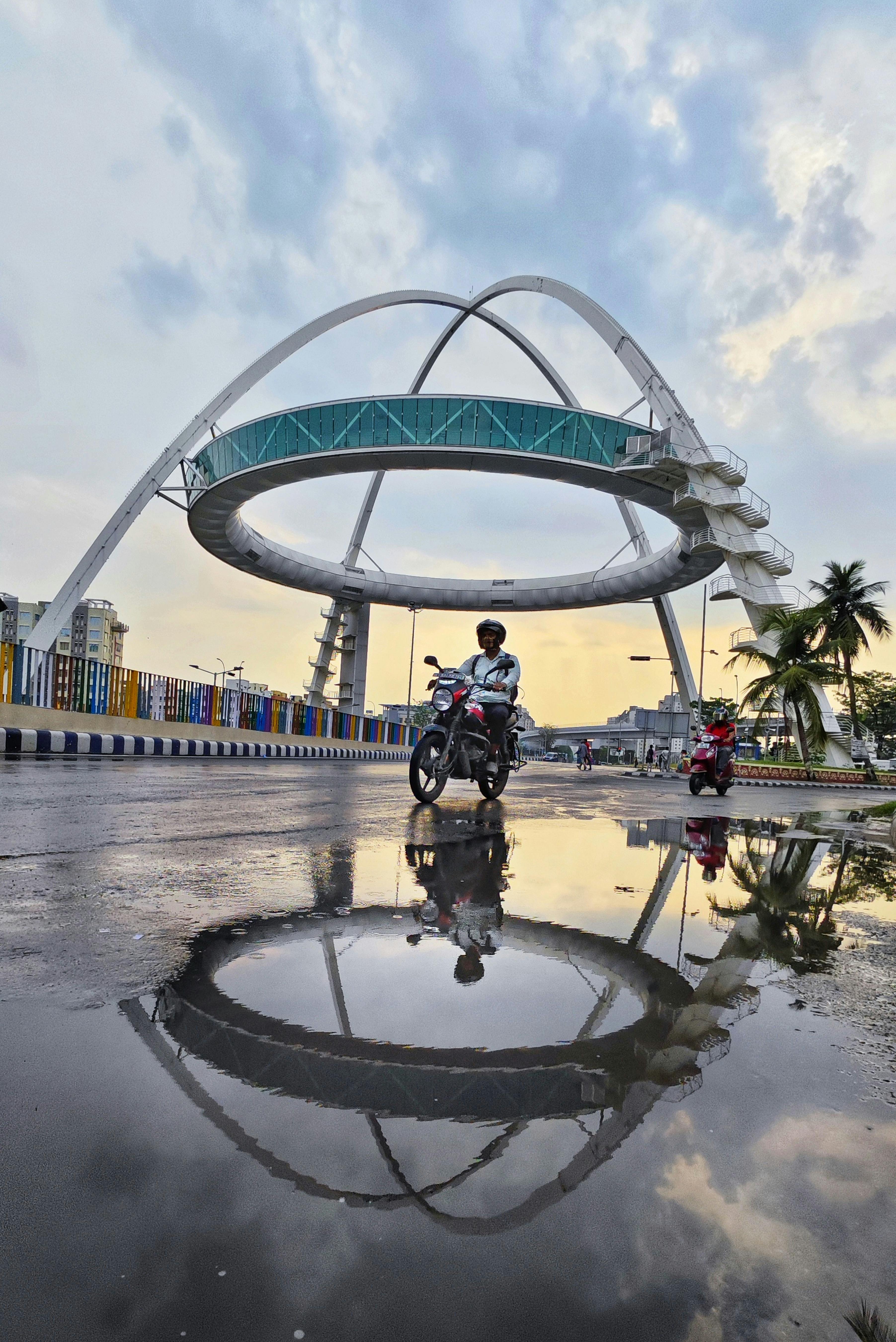 Man on a Motorbike under a Construction, Reflecting in a Puddle · Free ...