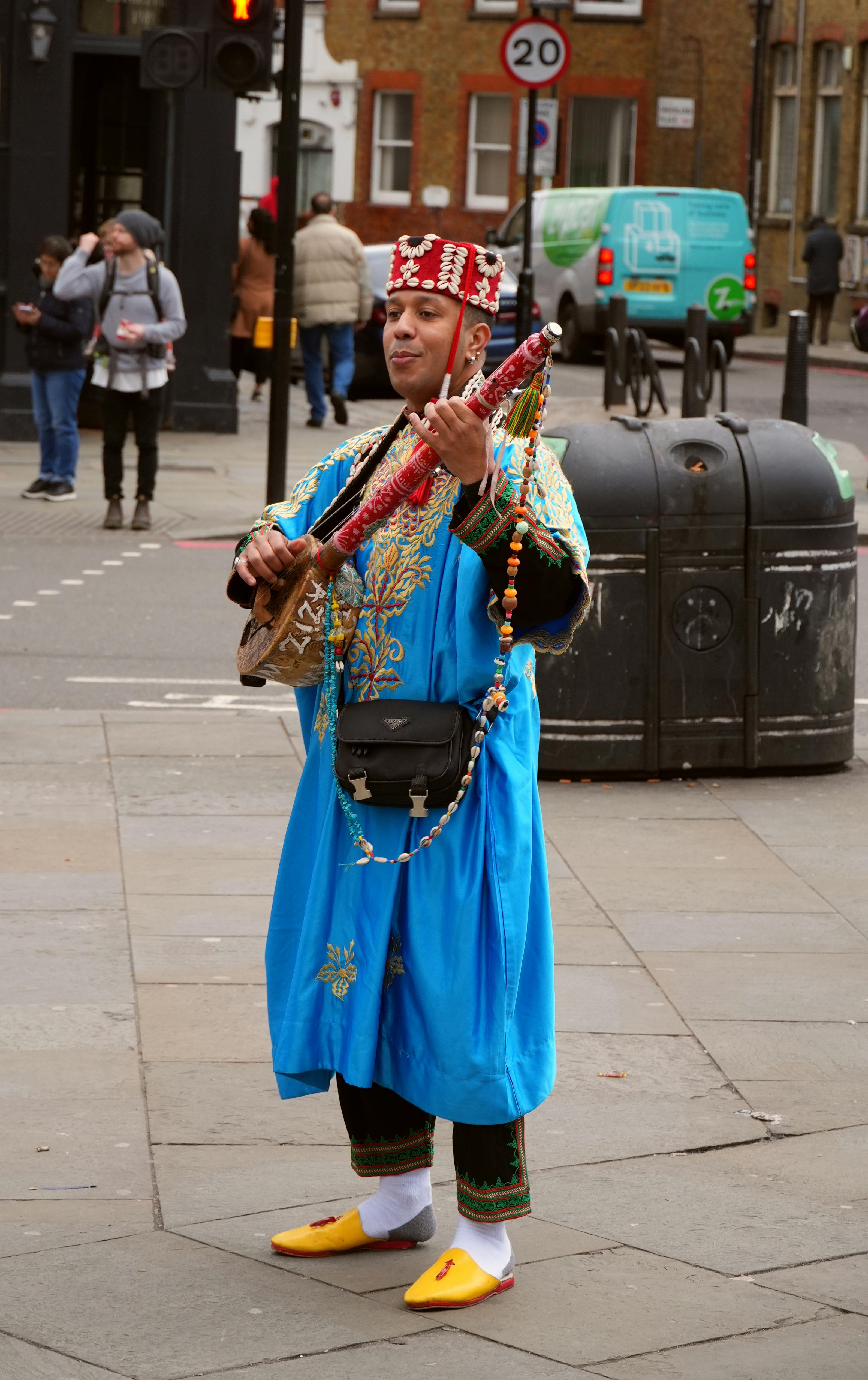 Man Wearing a Traditional Blue Gnawa Clothing, Playing Music on a ...