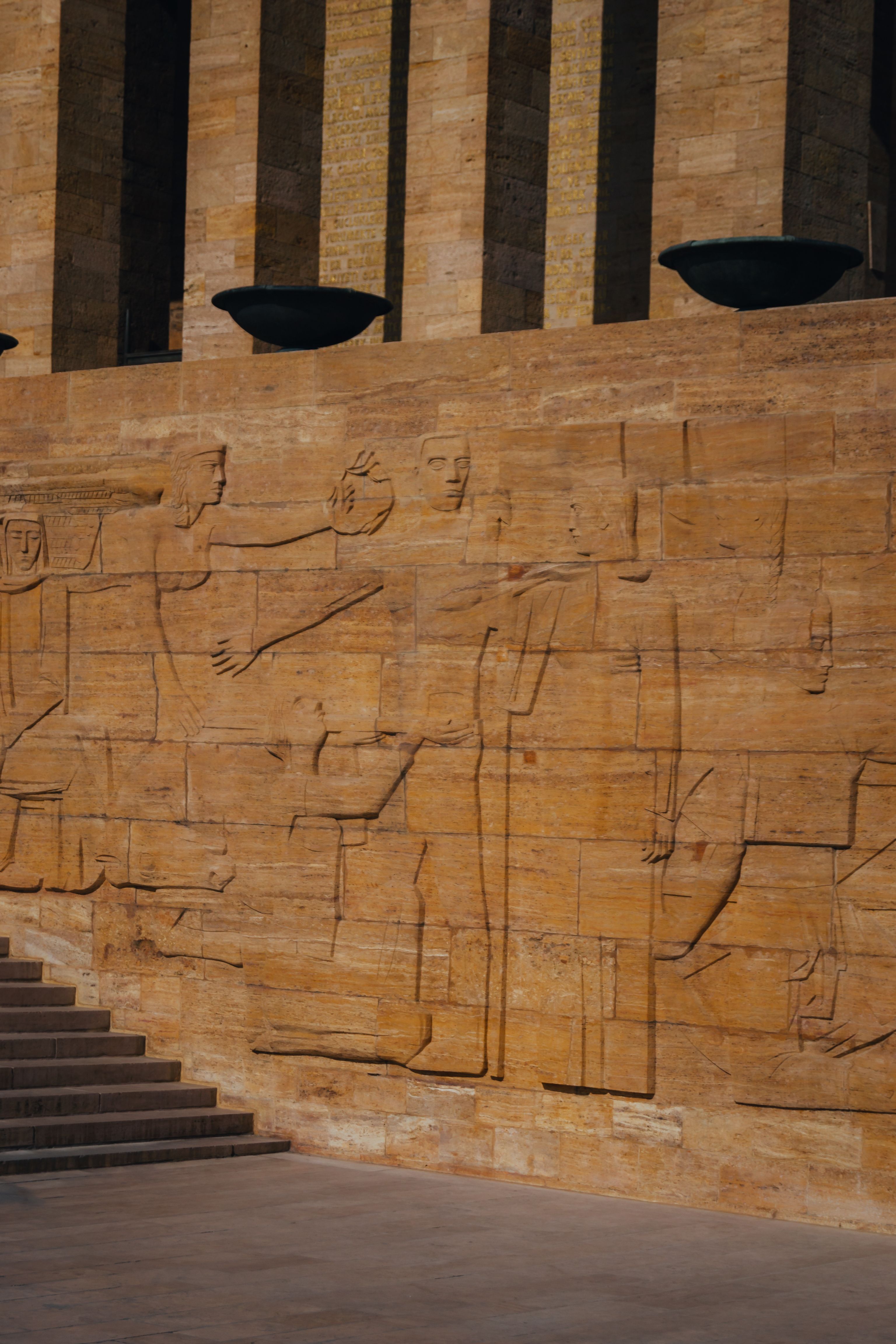 A stone wall with a sculpture on it · Free Stock Photo