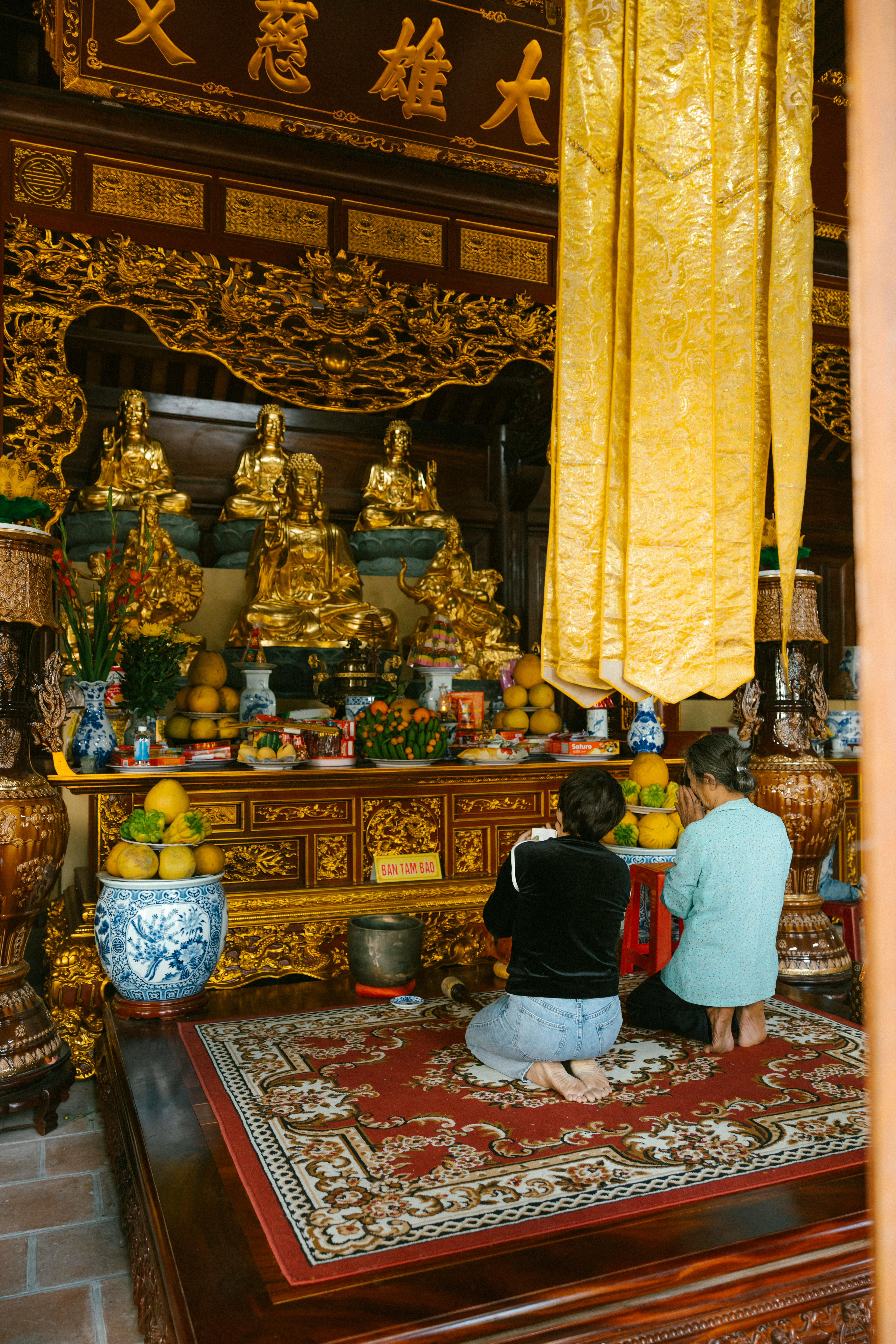 Two Women Kneeling in a Temple · Free Stock Photo
