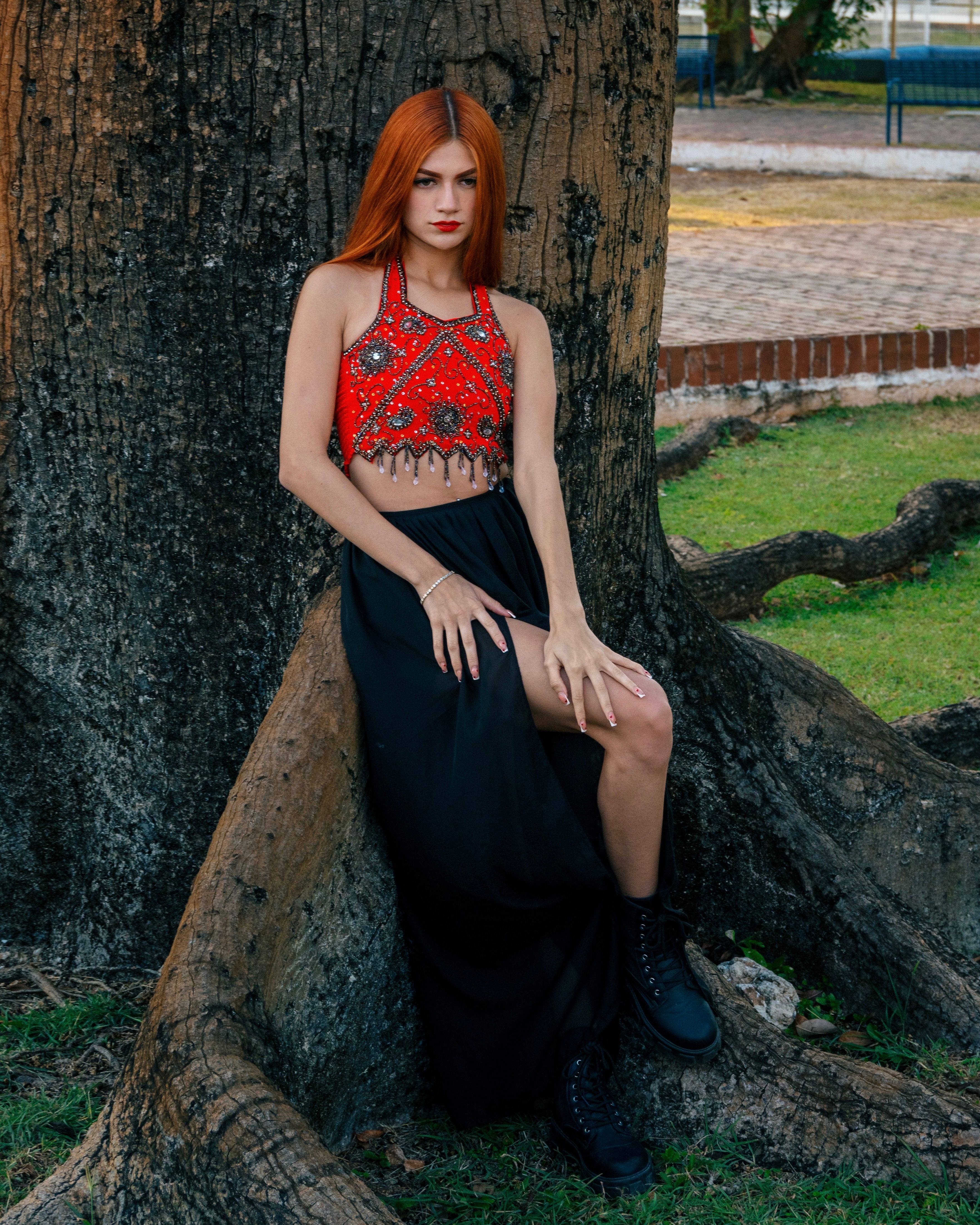 Woman with Ginger Hair Posing in a Park · Free Stock Photo