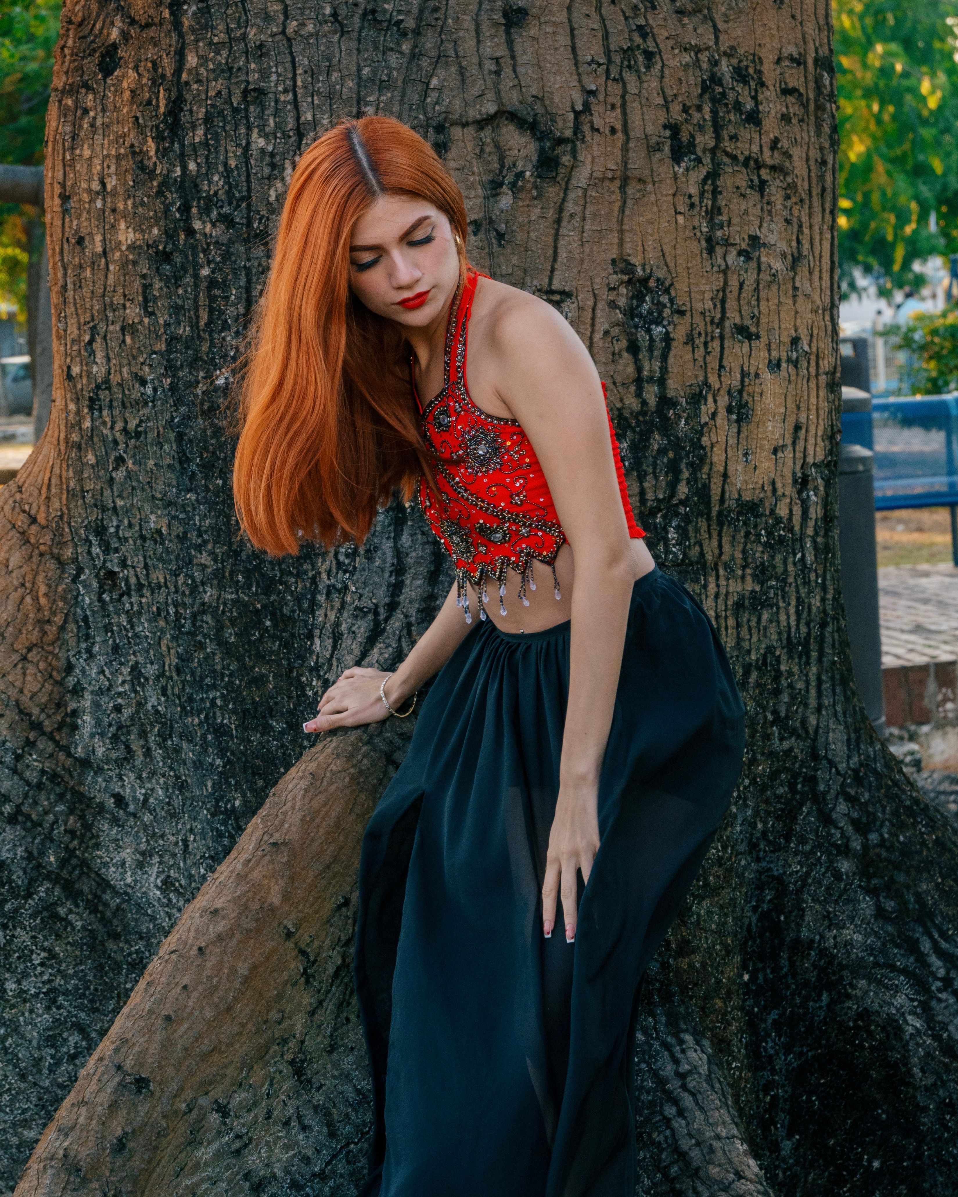Woman with Ginger Hair Posing in a Park · Free Stock Photo