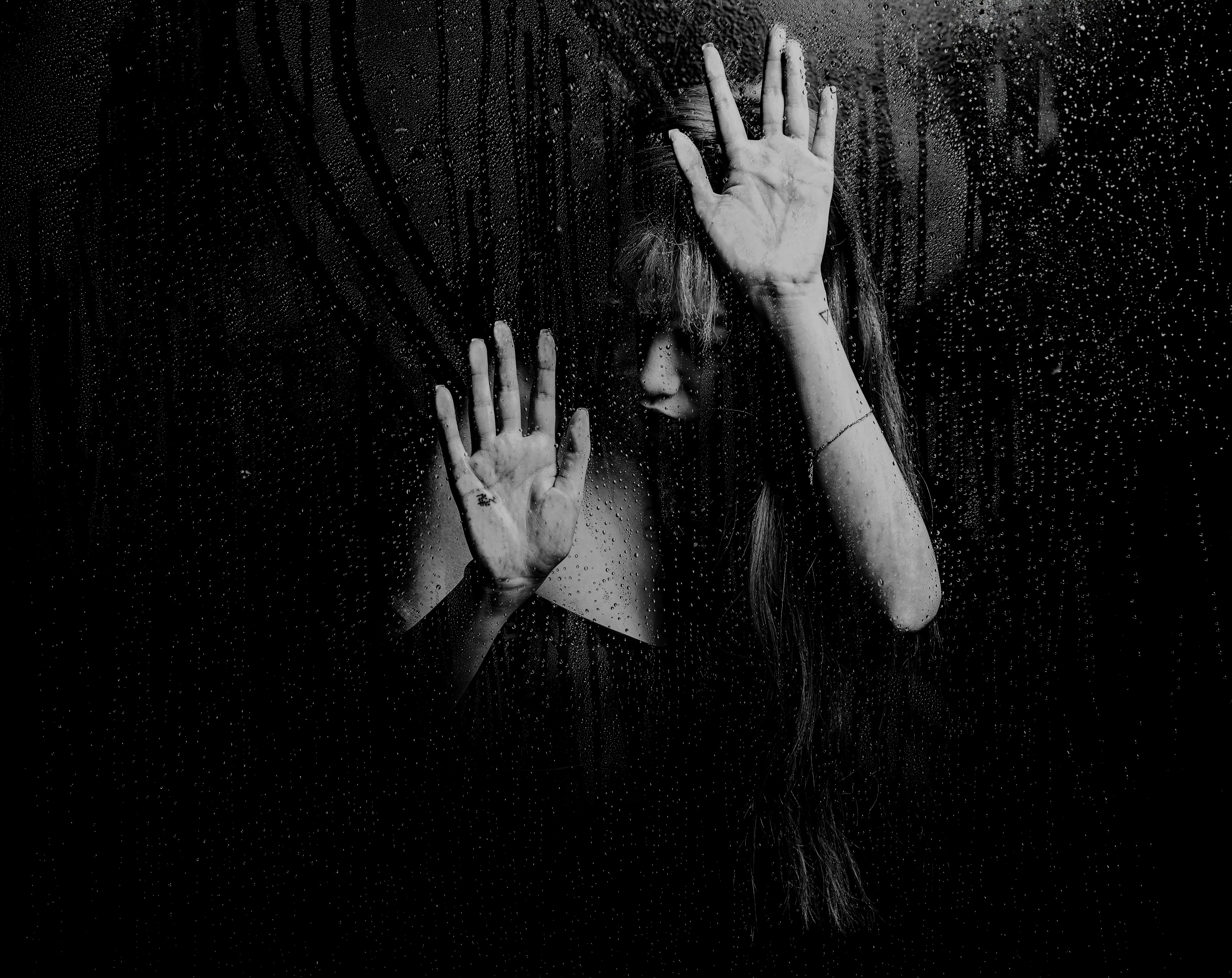Woman Holding Hands on Glass Window with Waterdrops · Free Stock Photo