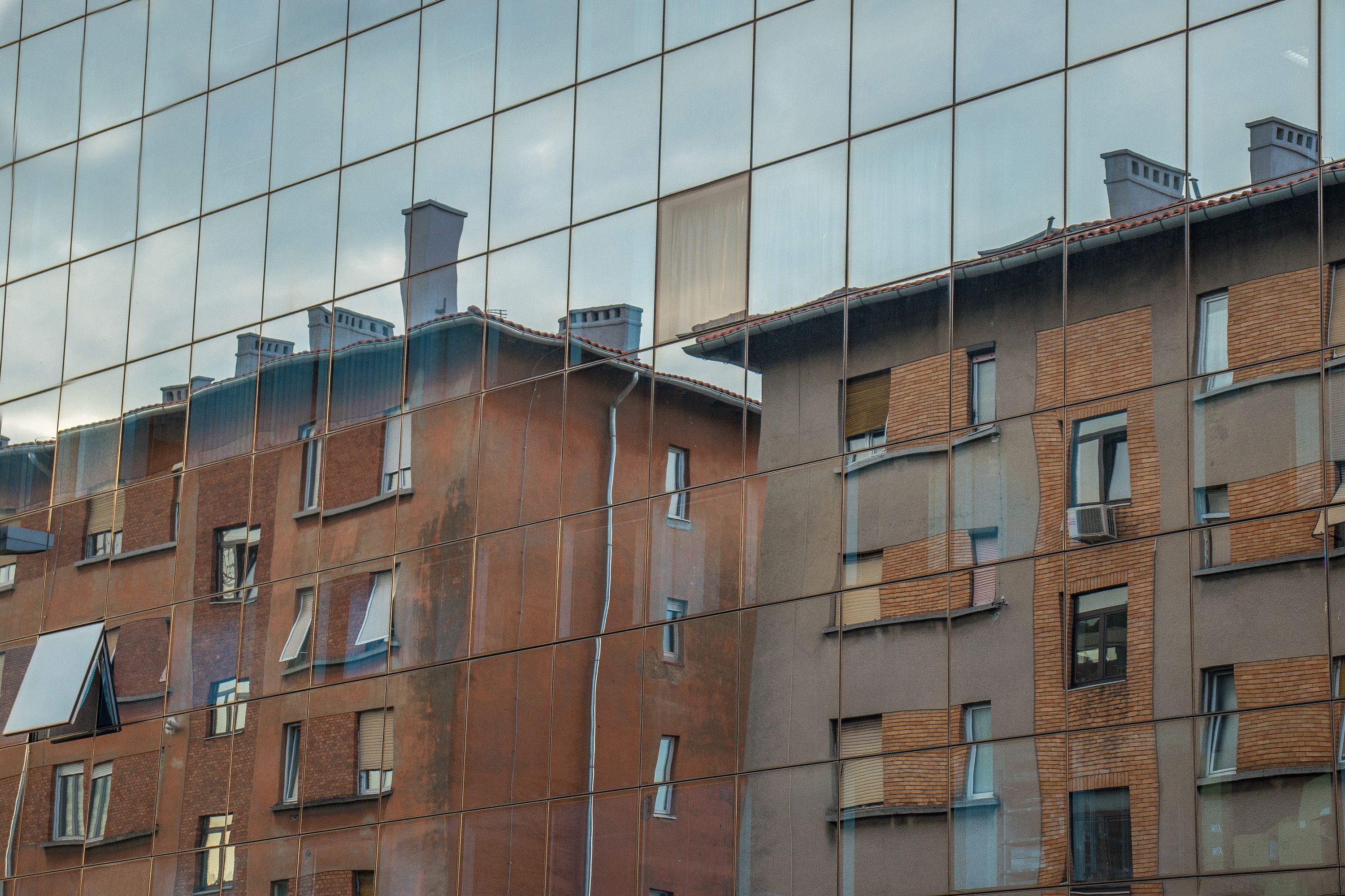 Reflection of Brick Apartment Buildings in the Glass Facade of a ...
