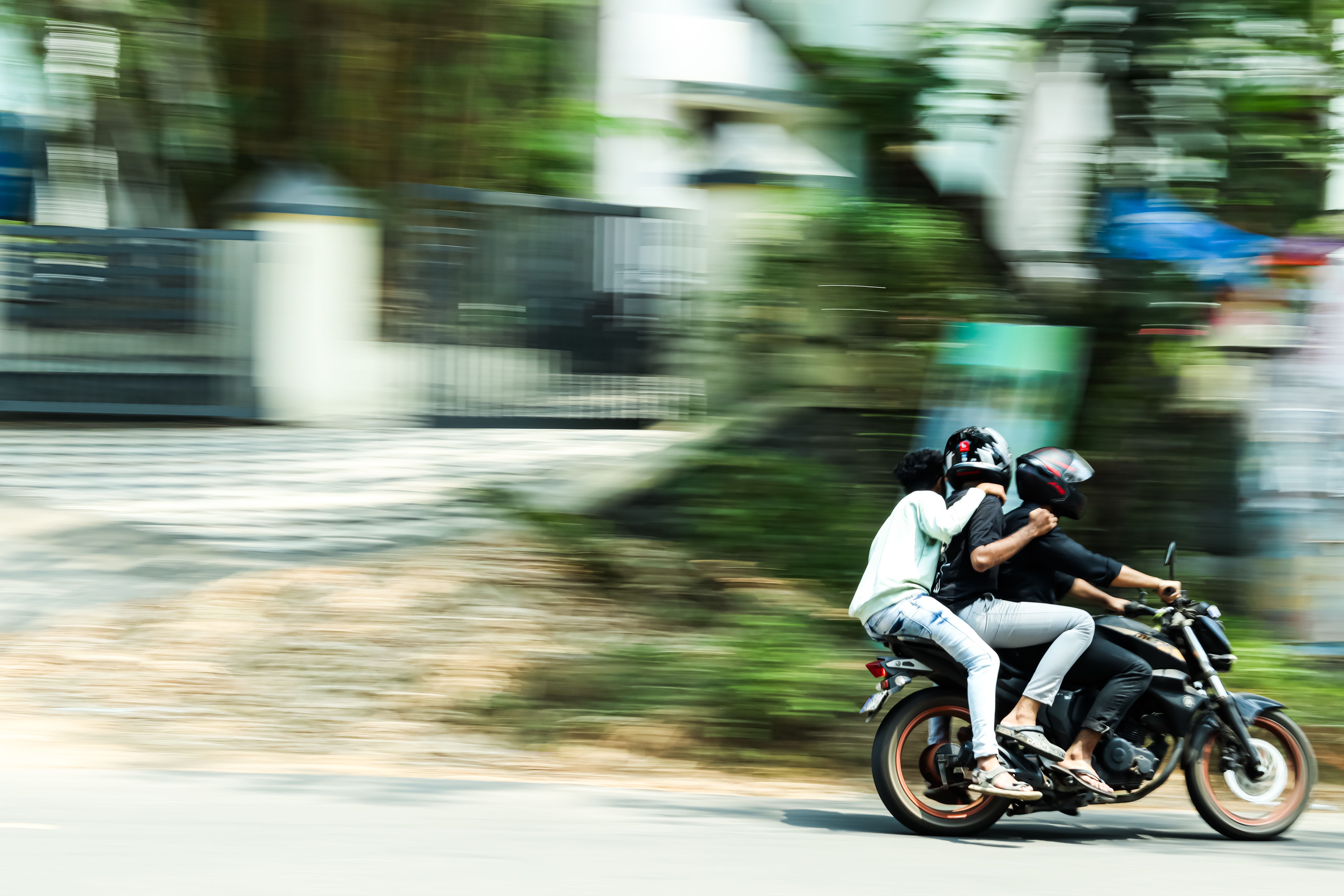 Three Friends Riding a Motorcycle · Free Stock Photo