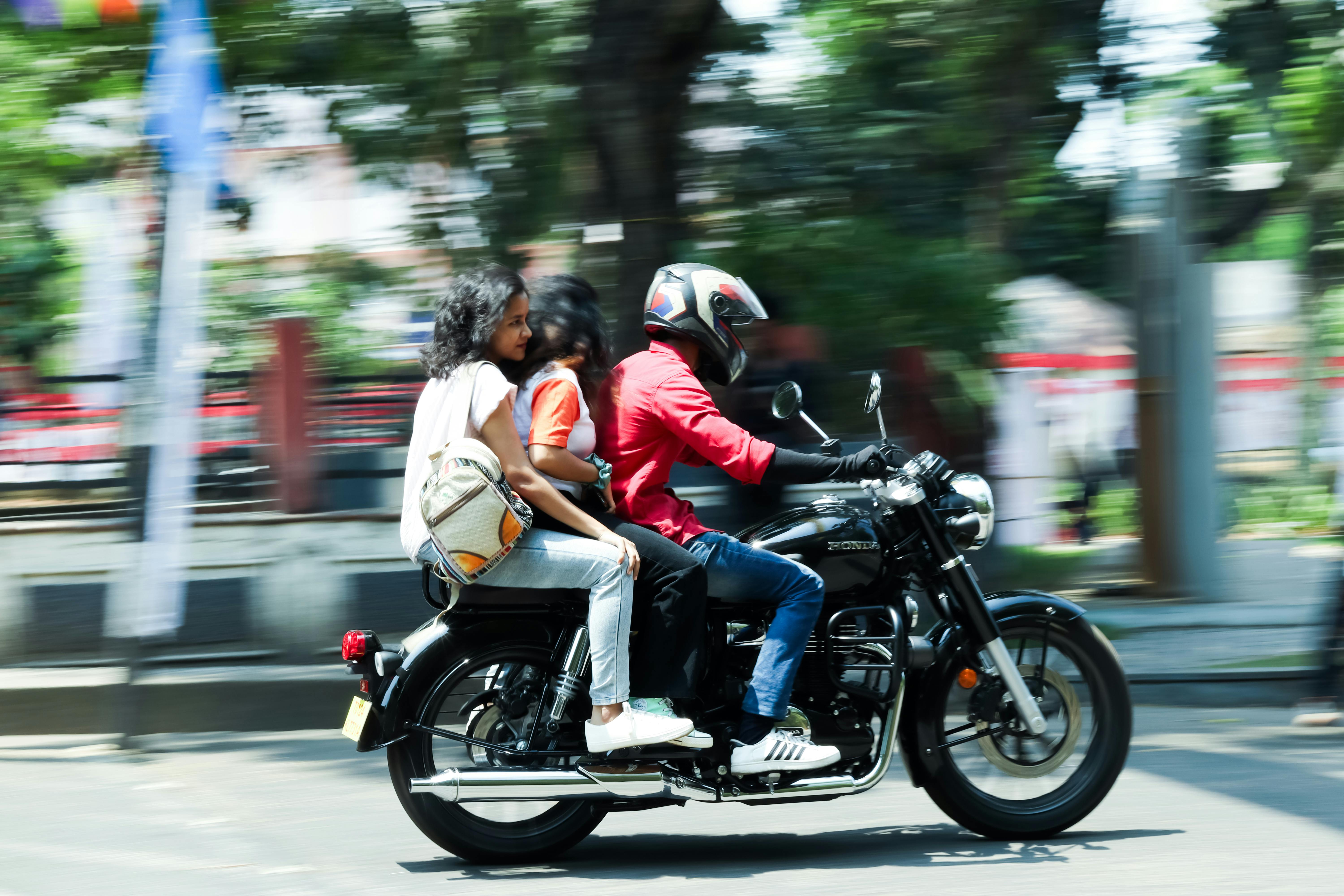 Man Carrying Two Women on a Motorcycle · Free Stock Photo