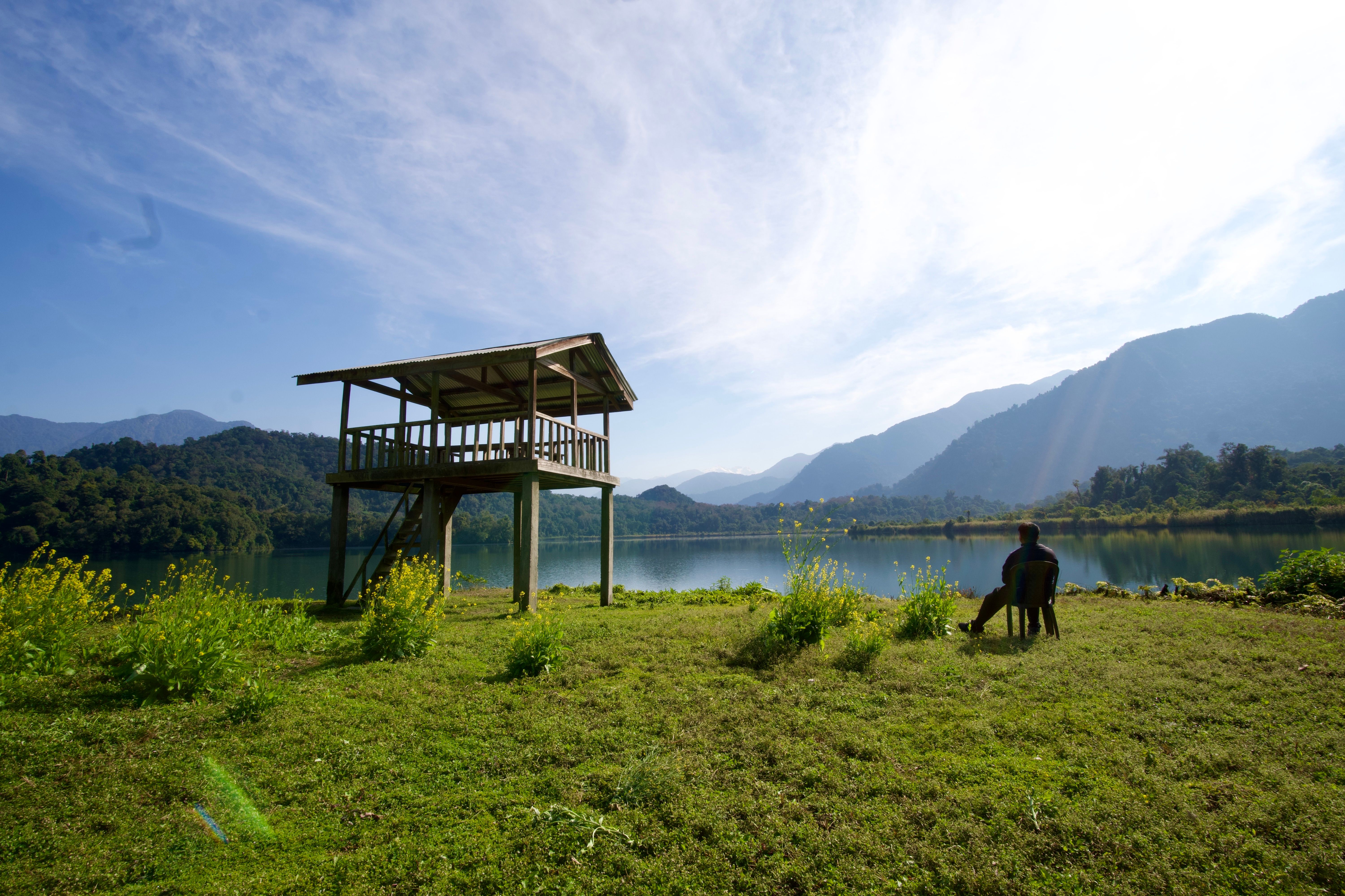 Tourist Sitting on Glow Lake Next to the Observation Tower · Free Stock ...
