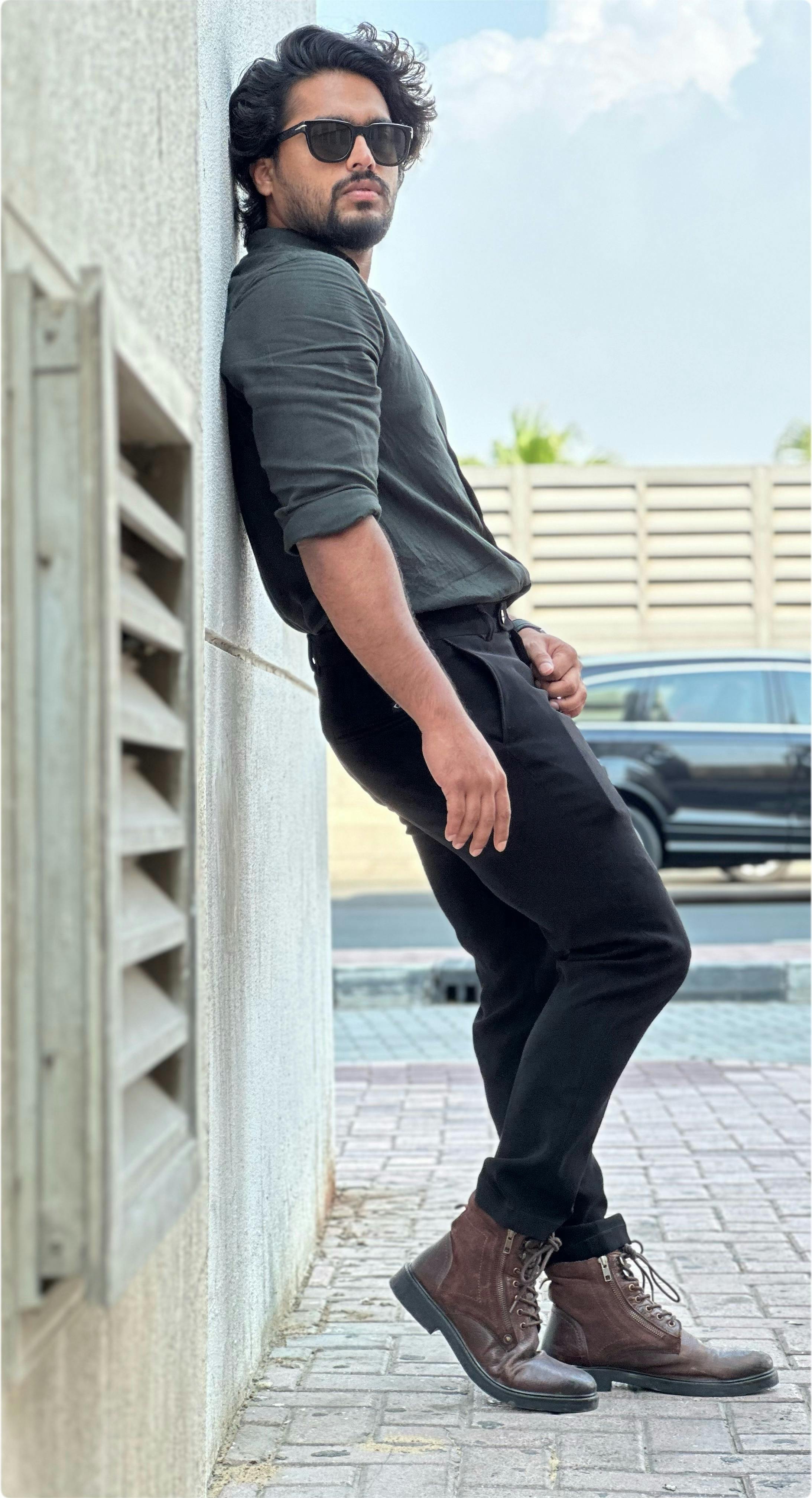 Man Leaning Against Concrete Wall · Free Stock Photo