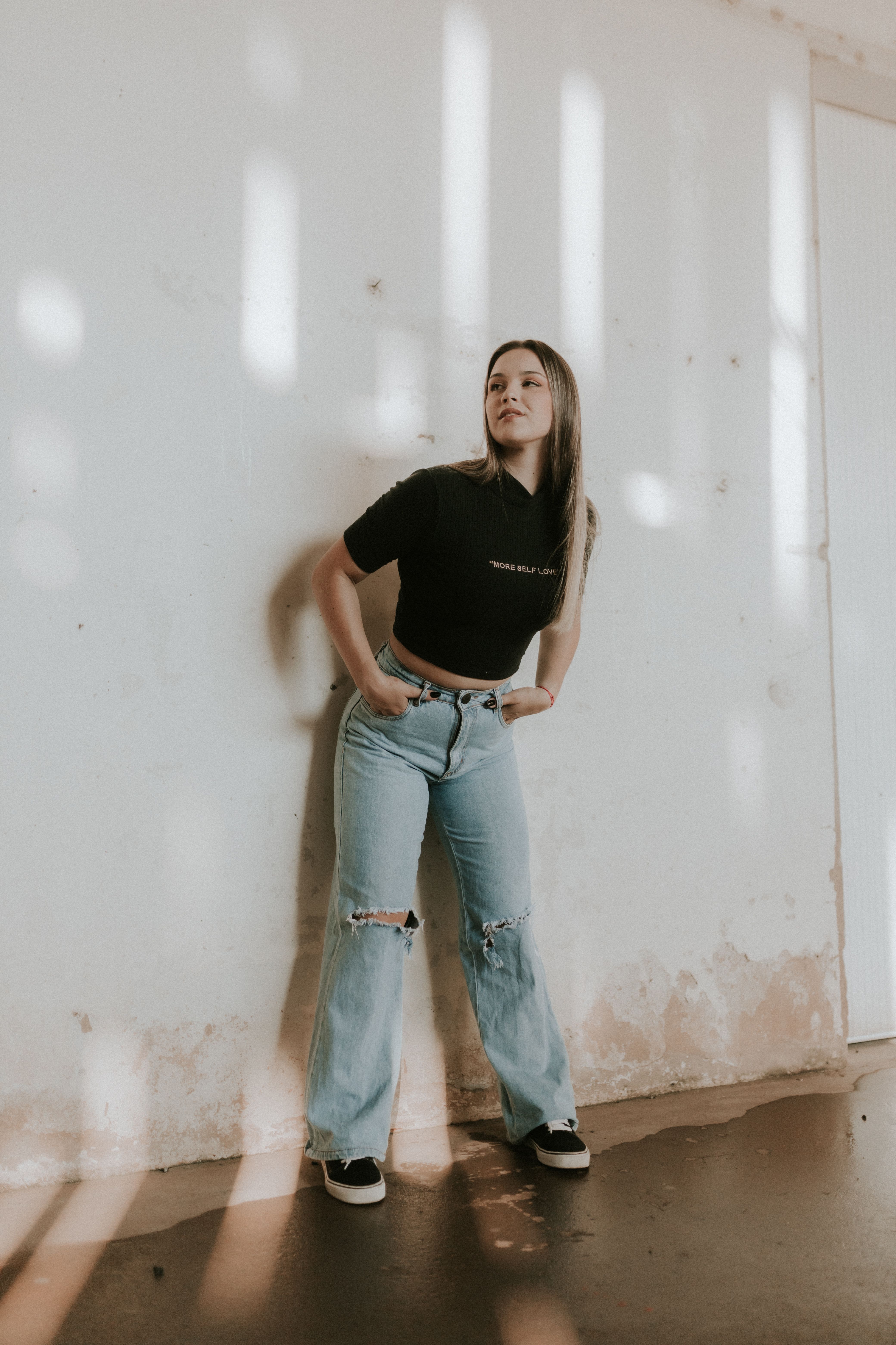 A Woman Posing by a Wall · Free Stock Photo