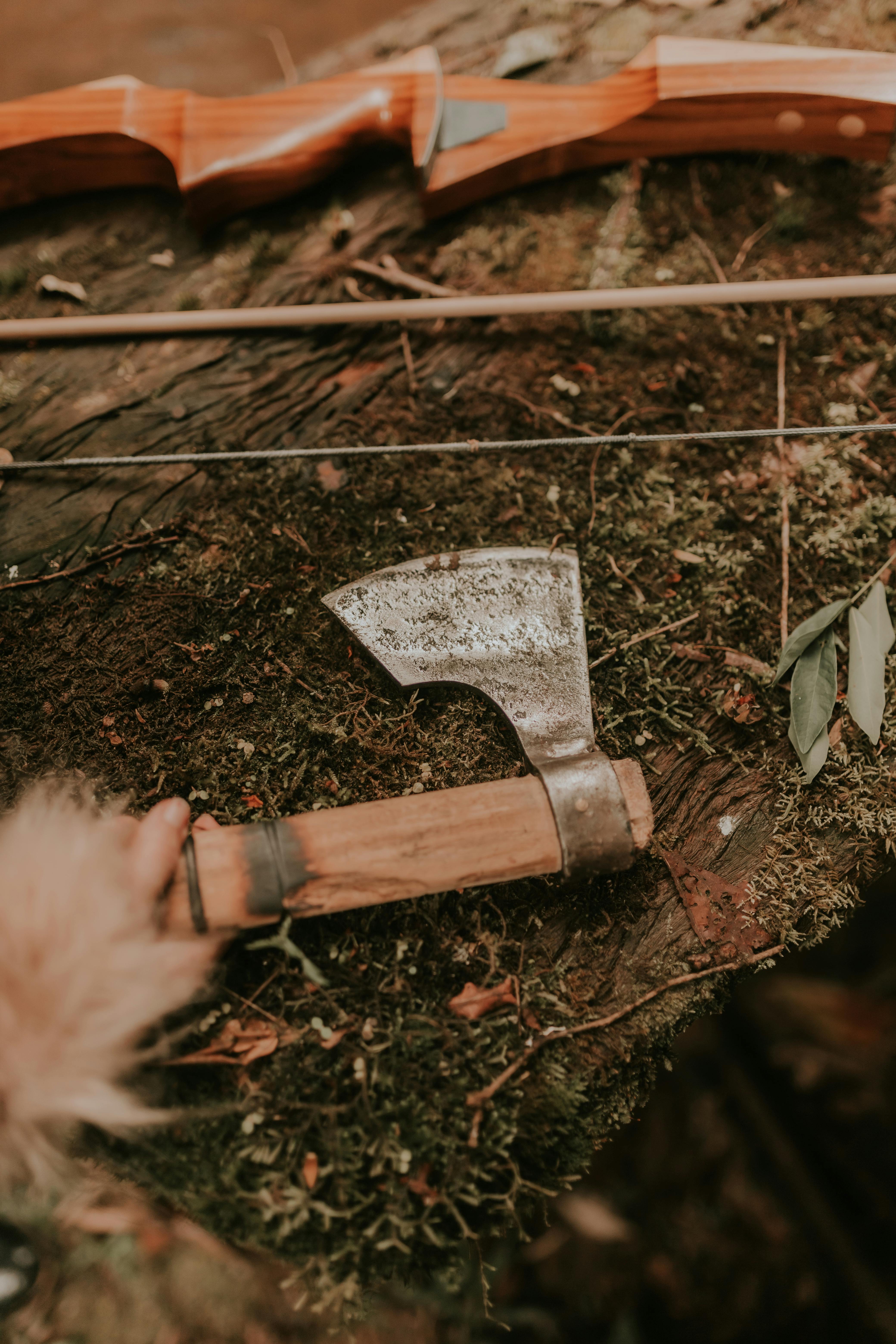 Axe and Bow on Ground · Free Stock Photo