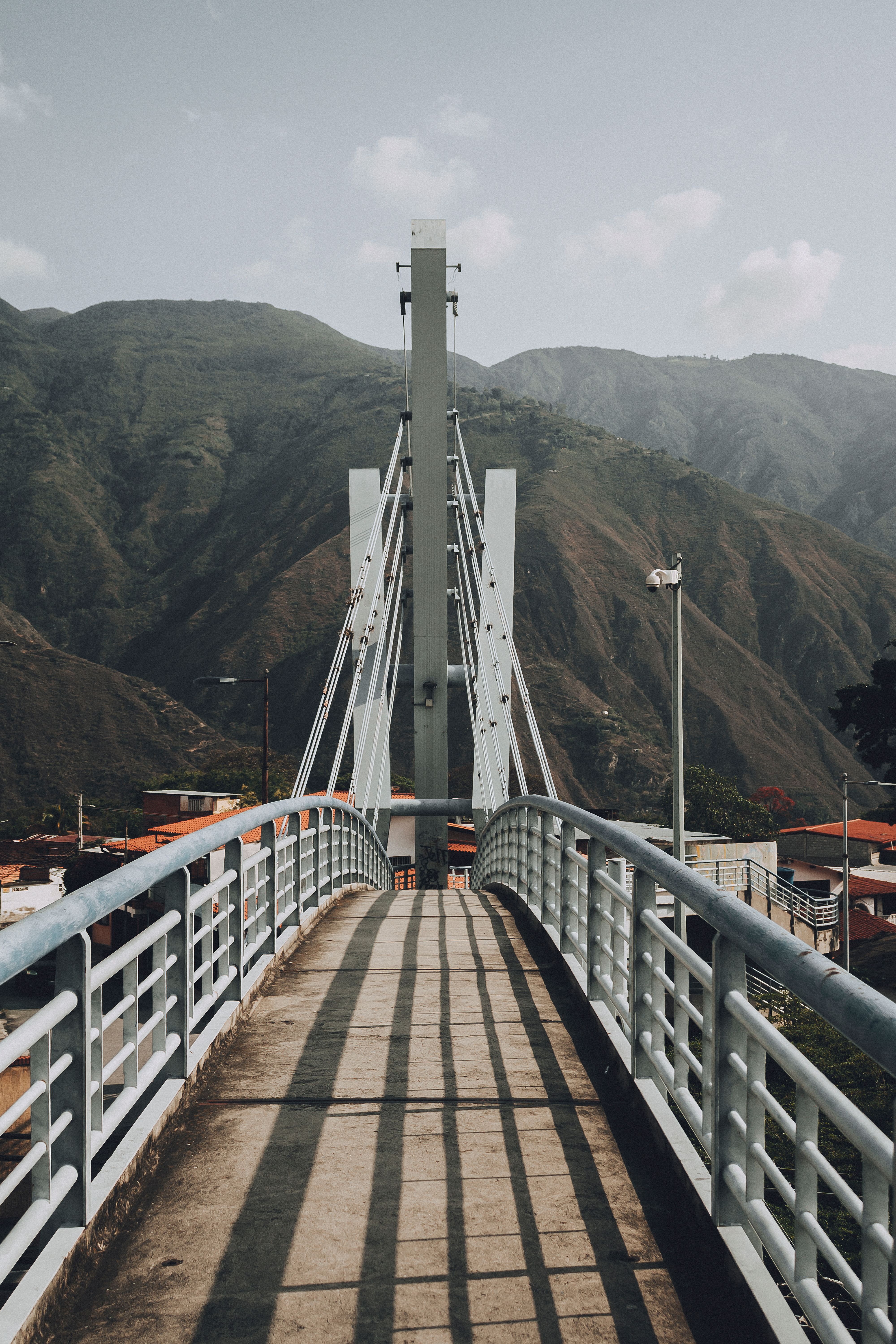 A bridge with a mountain in the background · Free Stock Photo