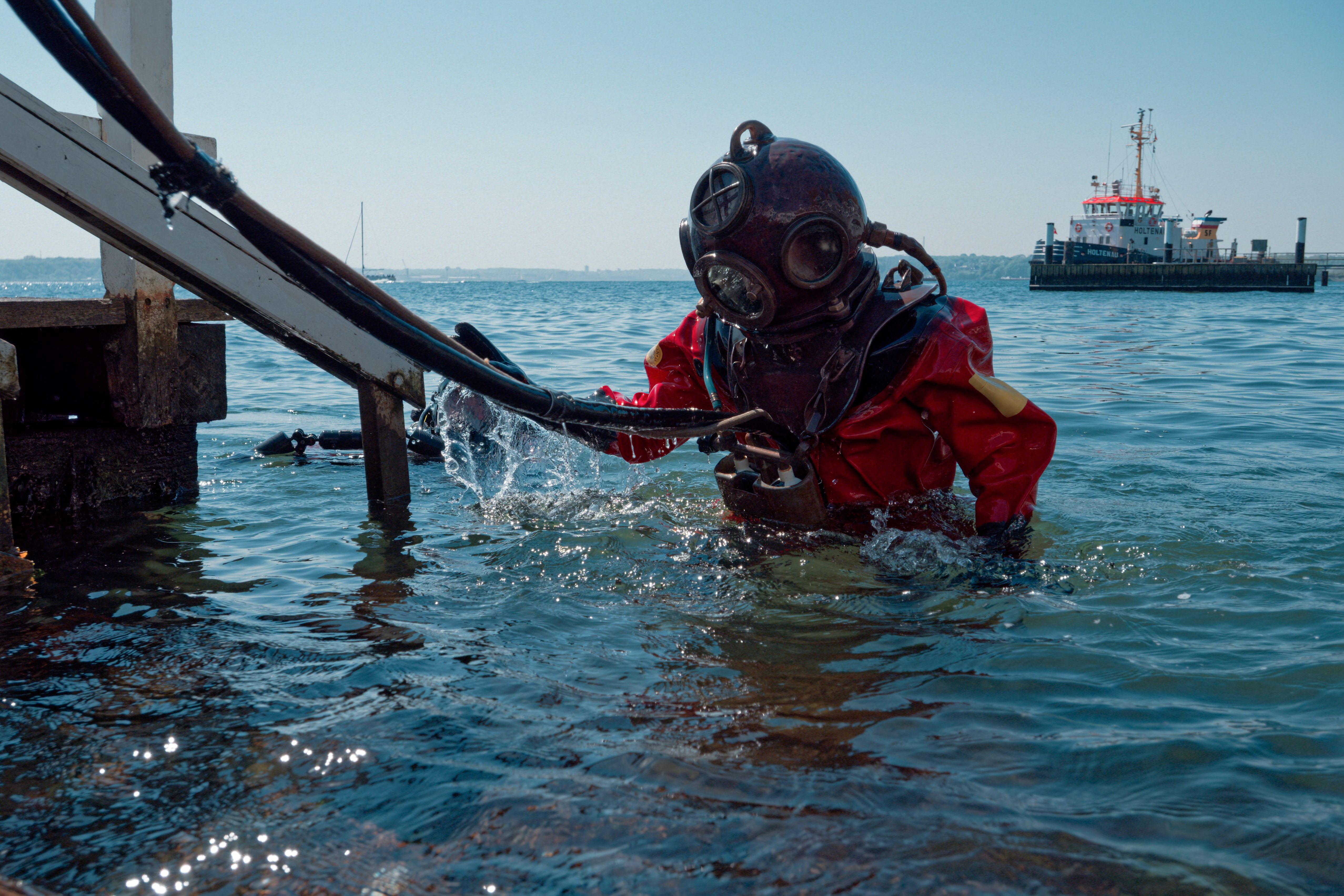 Diver in a Red Standard Diving Dress with a Brass Helmet Coming Out of ...