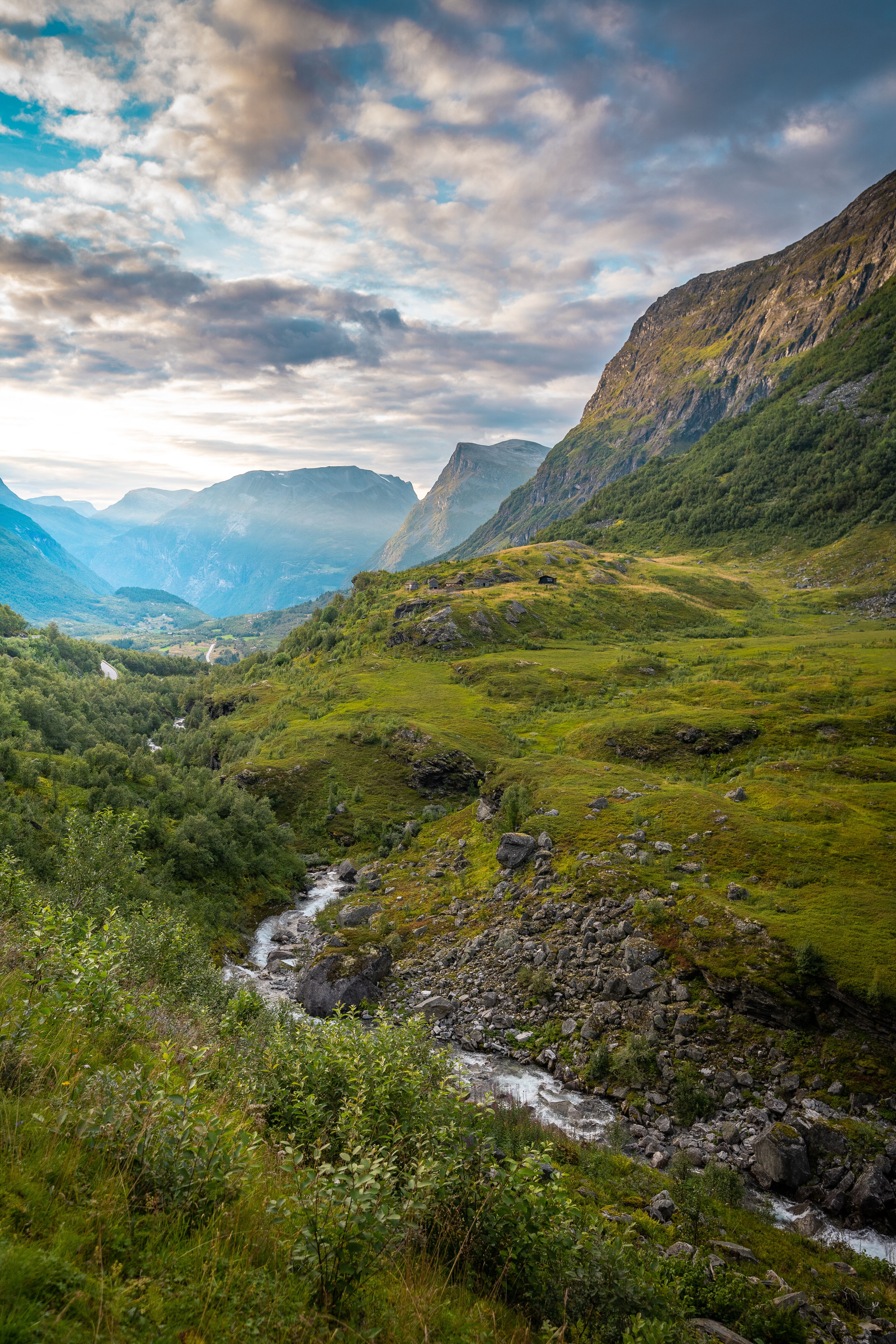 A scenic view of a valley with mountains and grass · Free Stock Photo