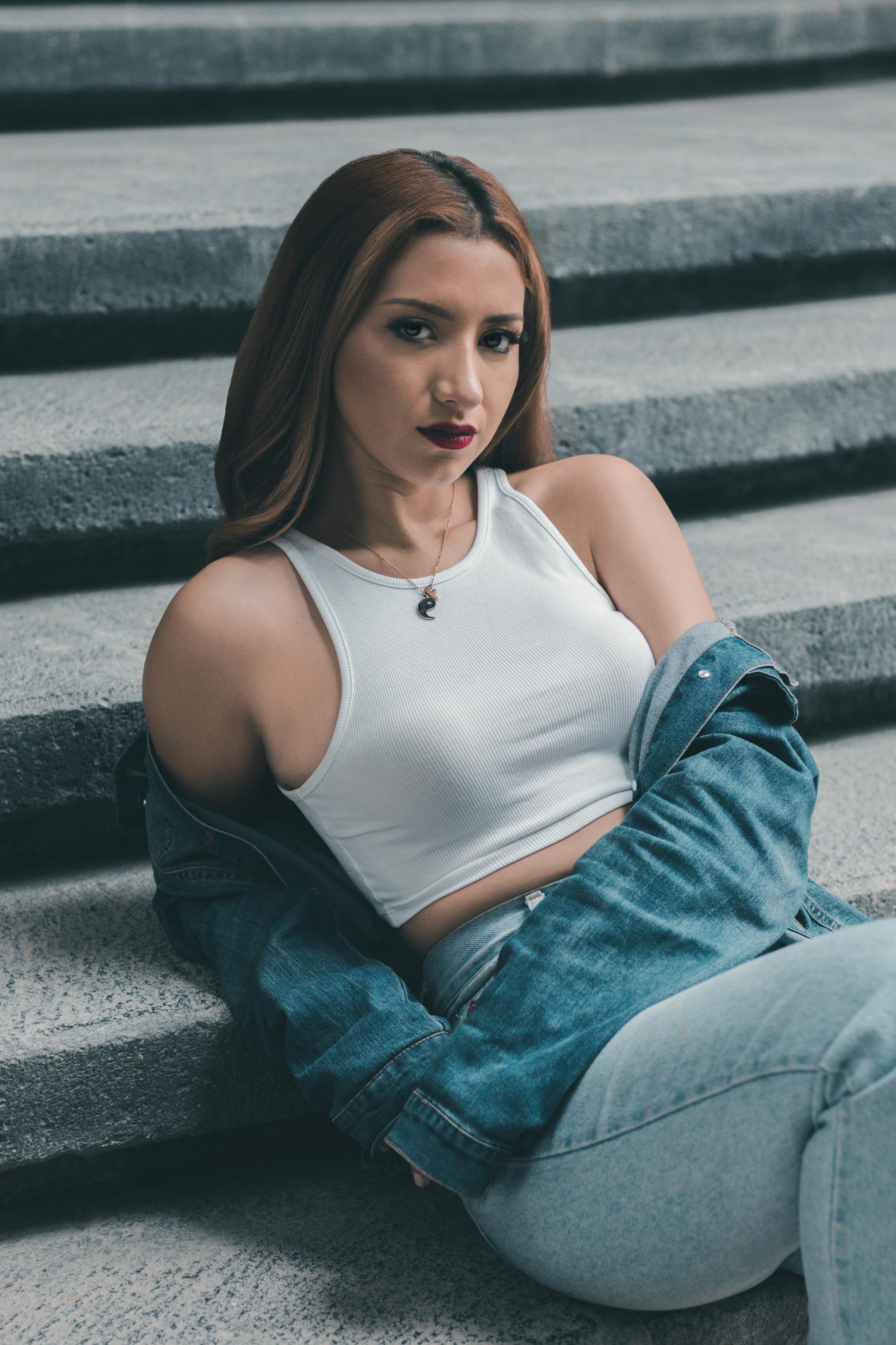 Woman in Jean Jacket Lying Down on Stairs · Free Stock Photo