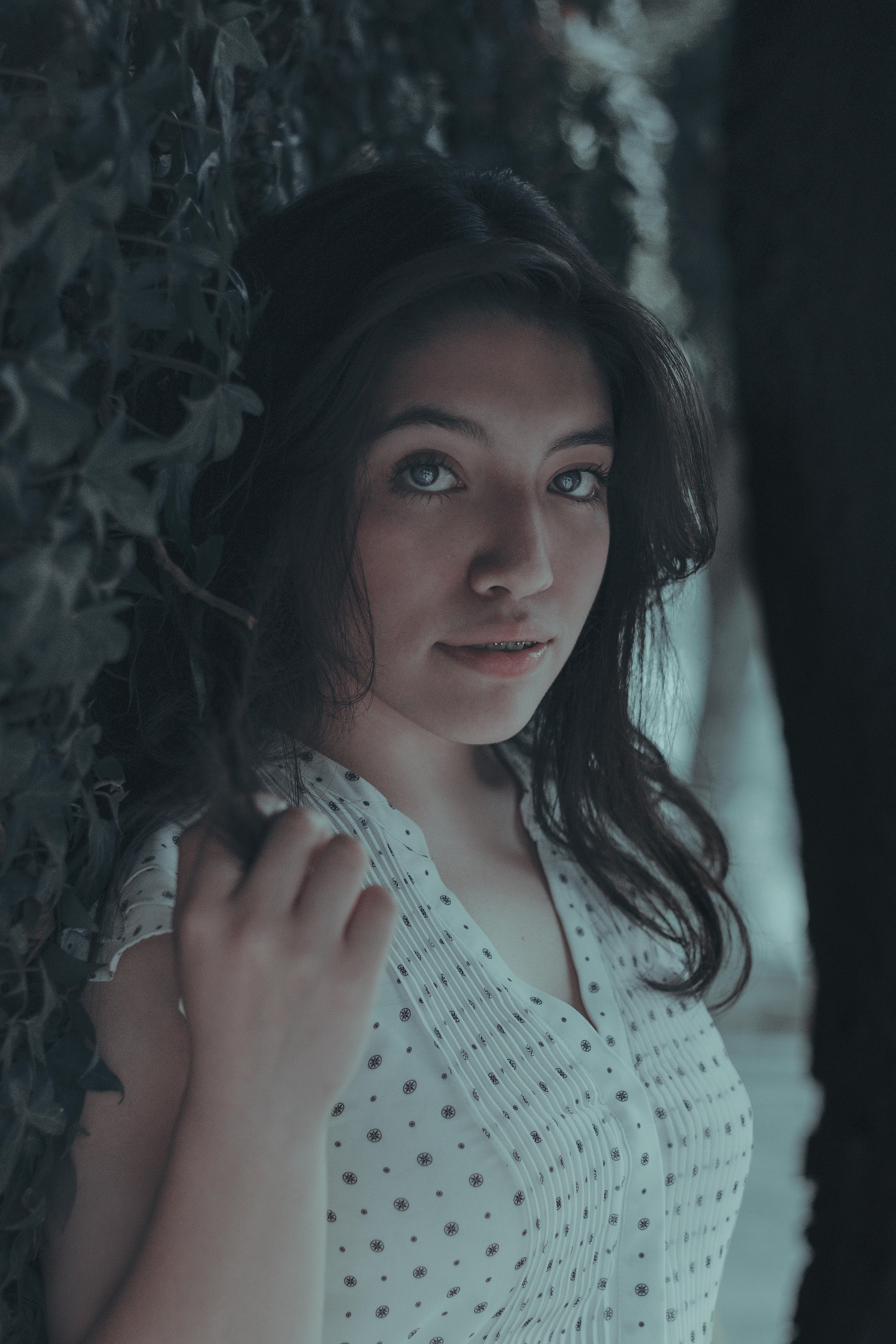 Portrait of Woman Standing with Leaves behind · Free Stock Photo