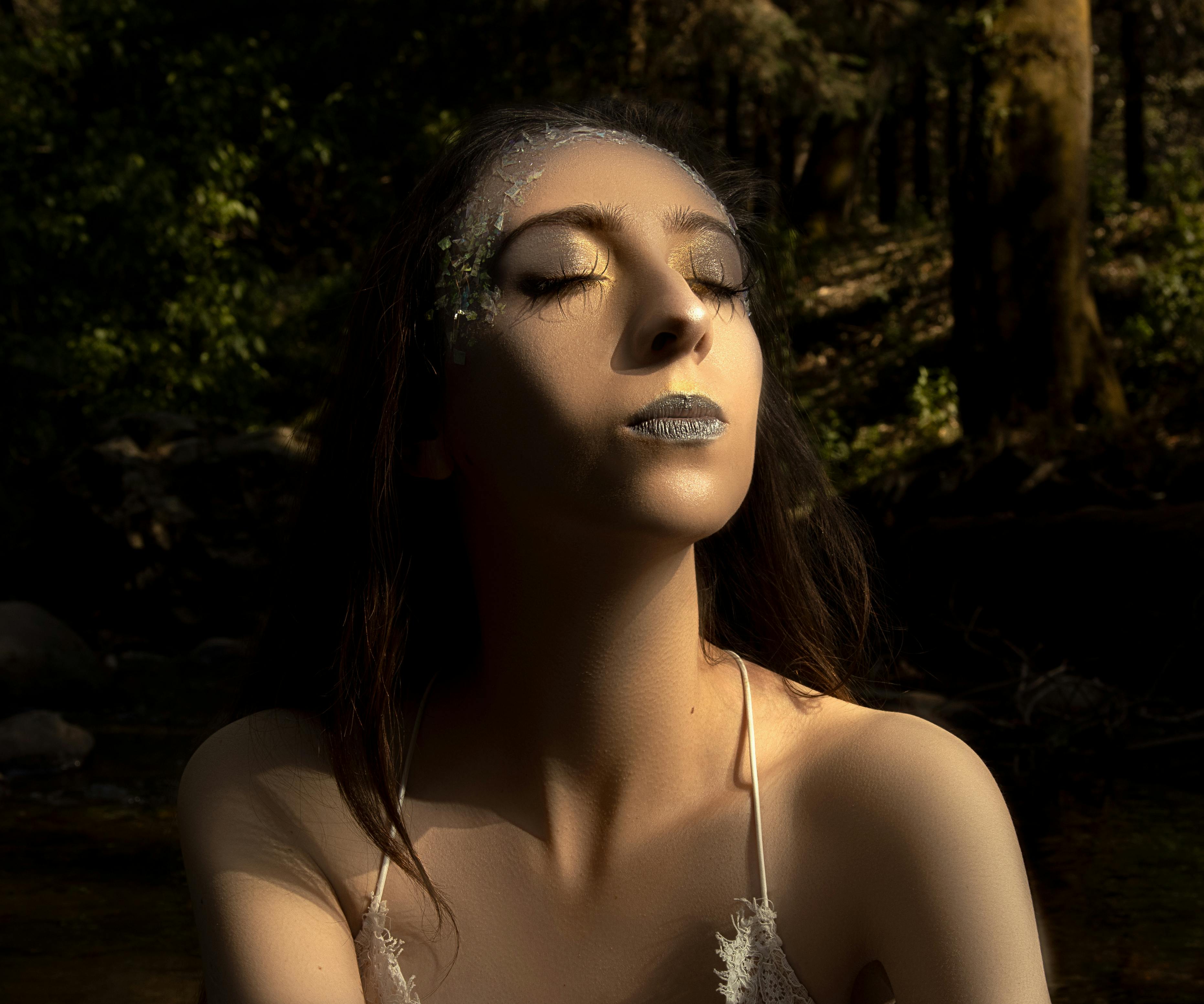 A woman with silver makeup and a white dress · Free Stock Photo