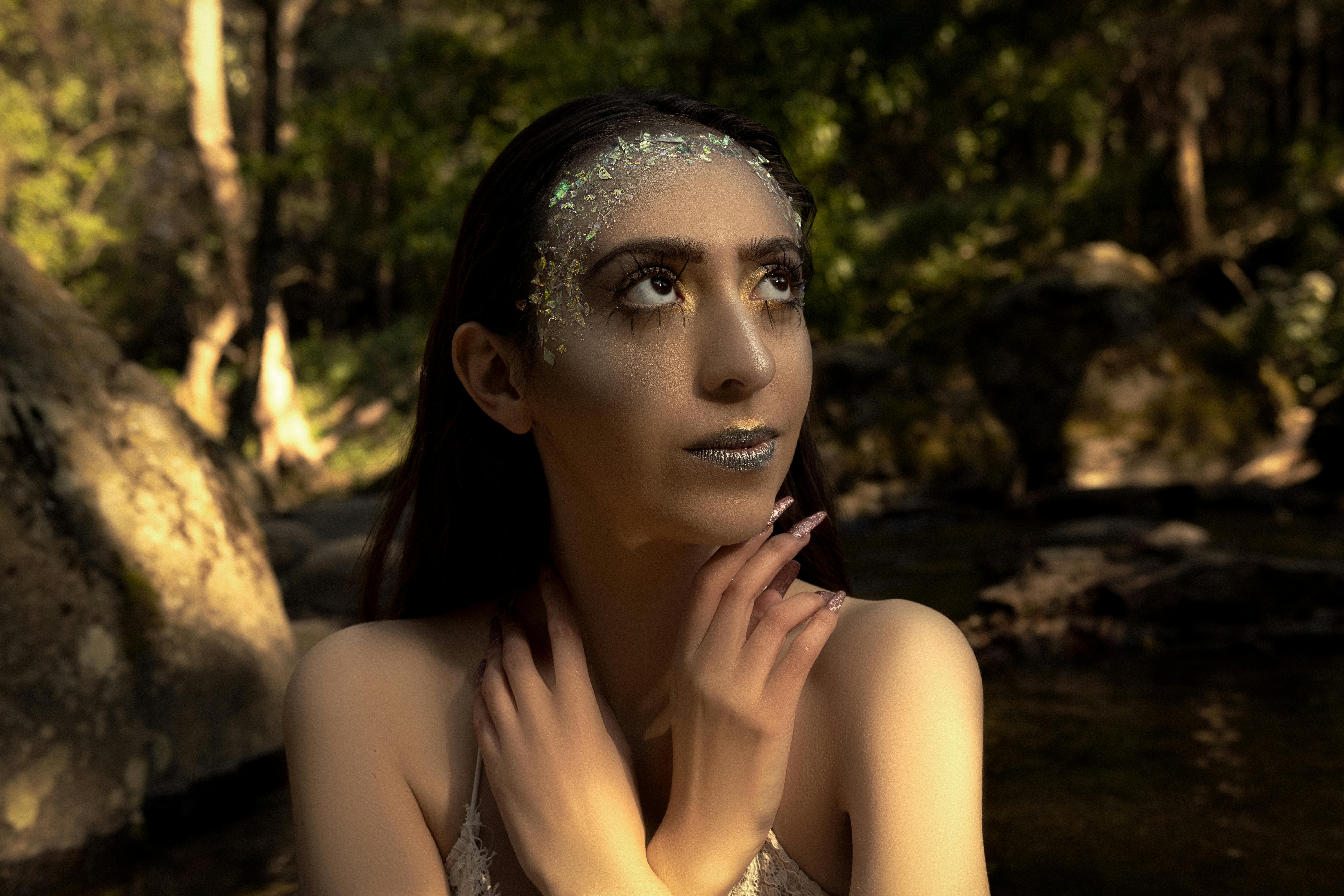 Woman with Makeup Looking Up in Forest · Free Stock Photo