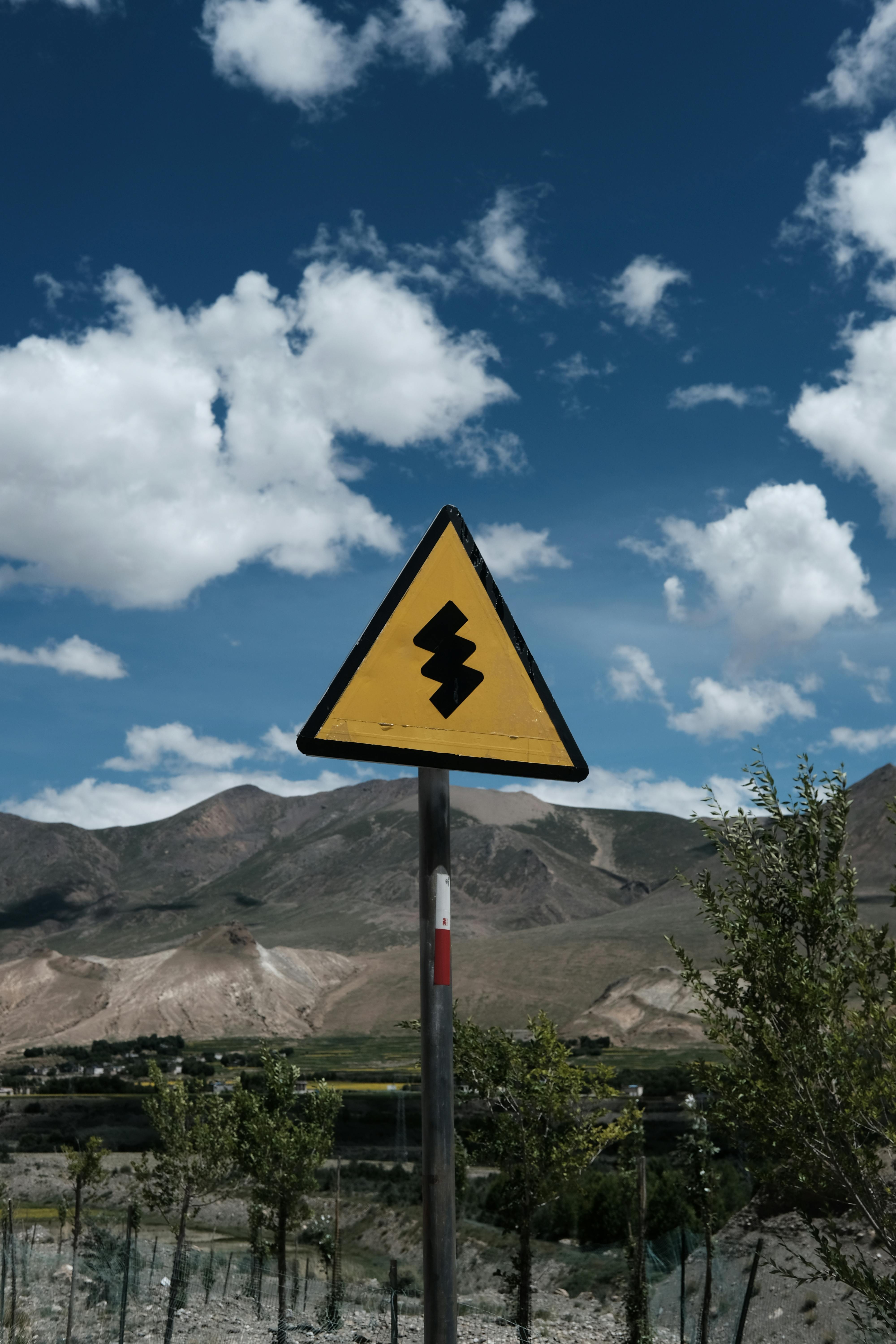 A yellow warning sign with a lightning bolt on it · Free Stock Photo
