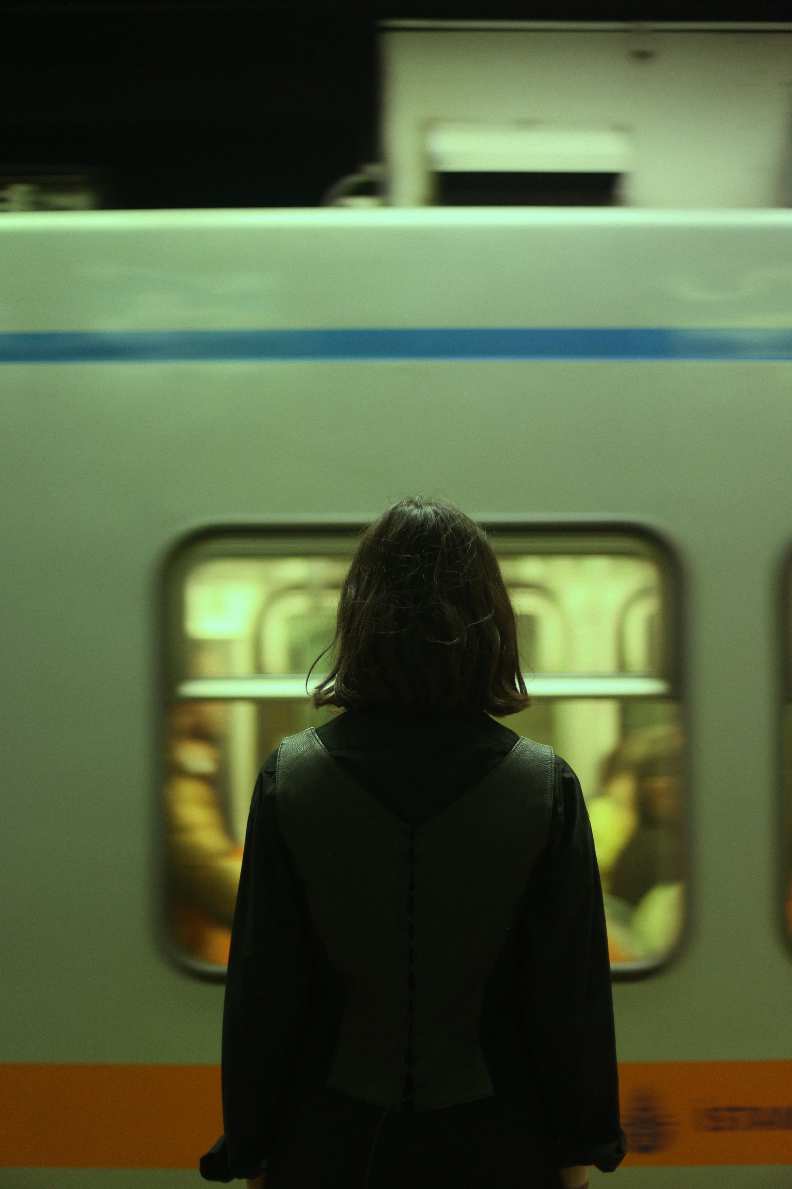 Back View of a Woman Standing on a Subway Station · Free Stock Photo