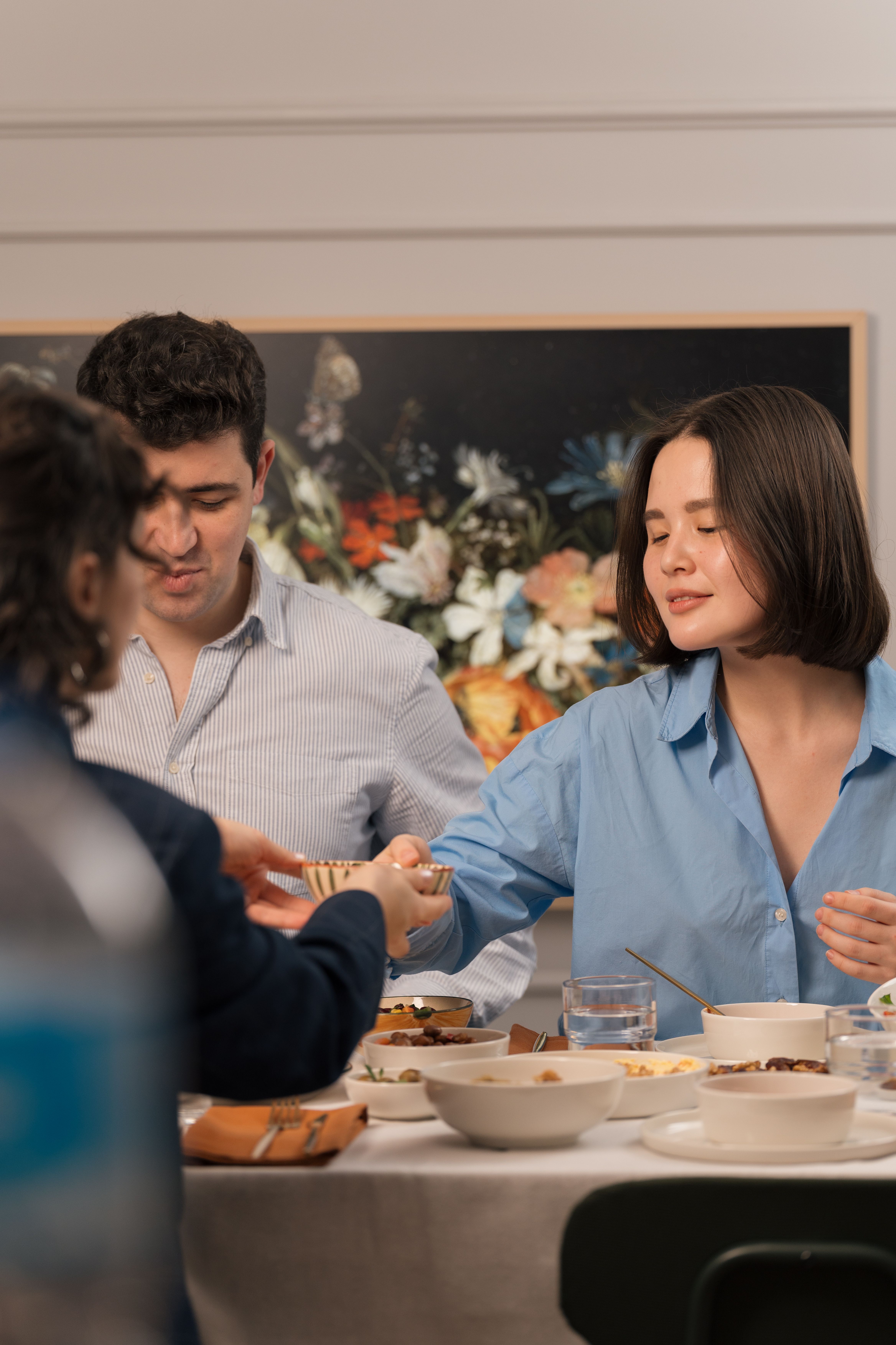 A woman and man eating dinner at a table · Free Stock Photo