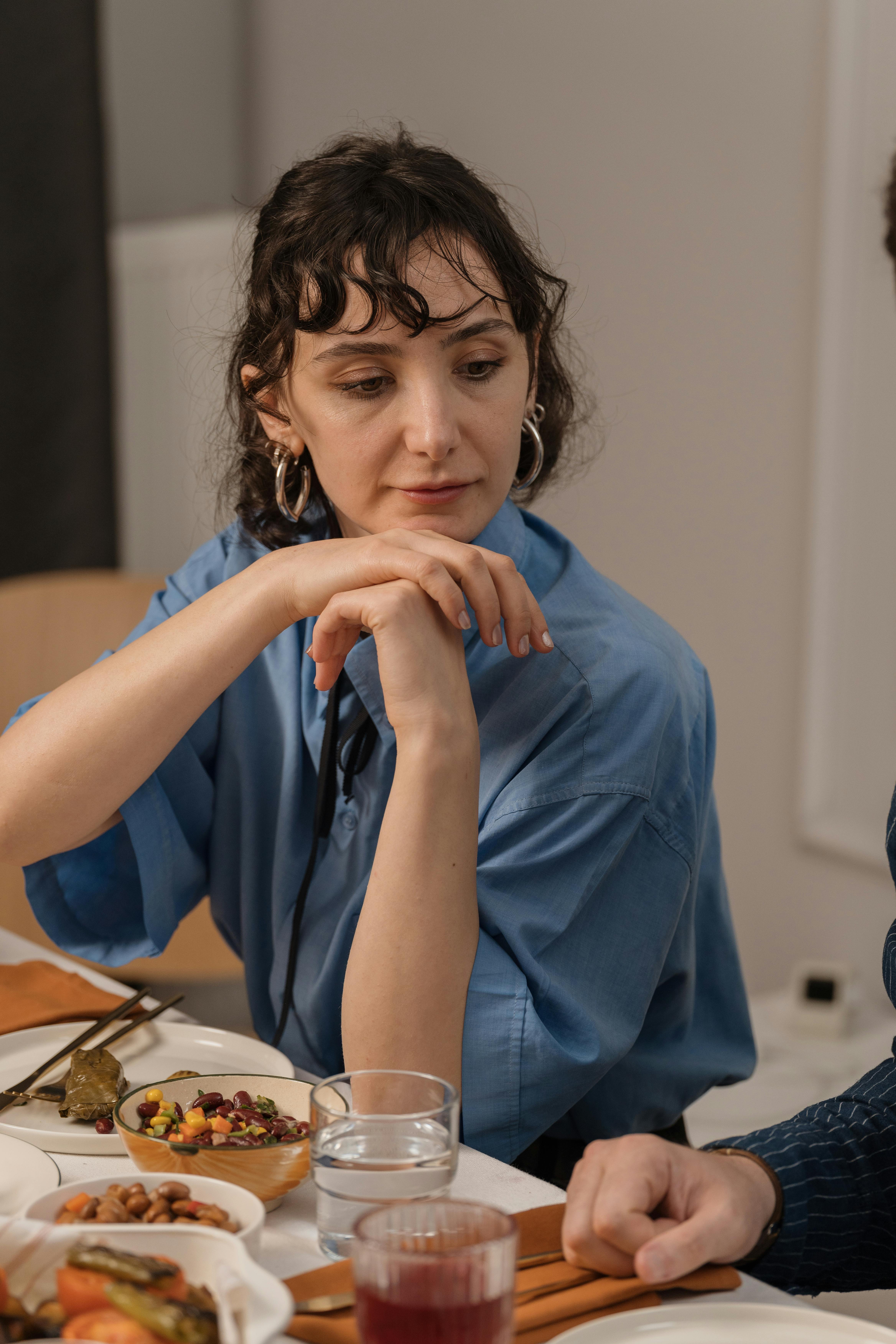 Brunette Woman Sitting by the Table During Dinner · Free Stock Photo