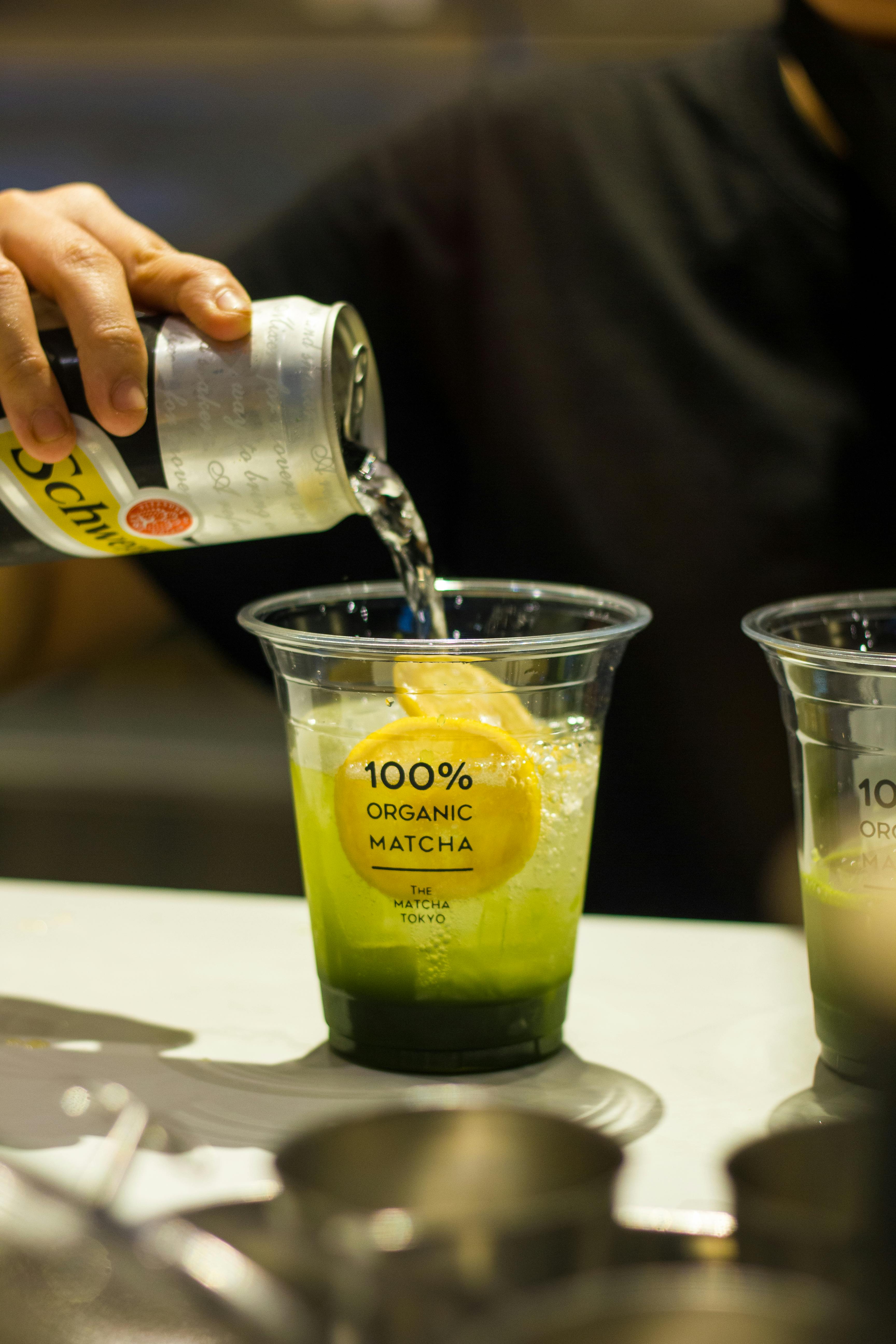 Man Hand Holding Can of Schweppes and Pouring to Cup · Free Stock Photo