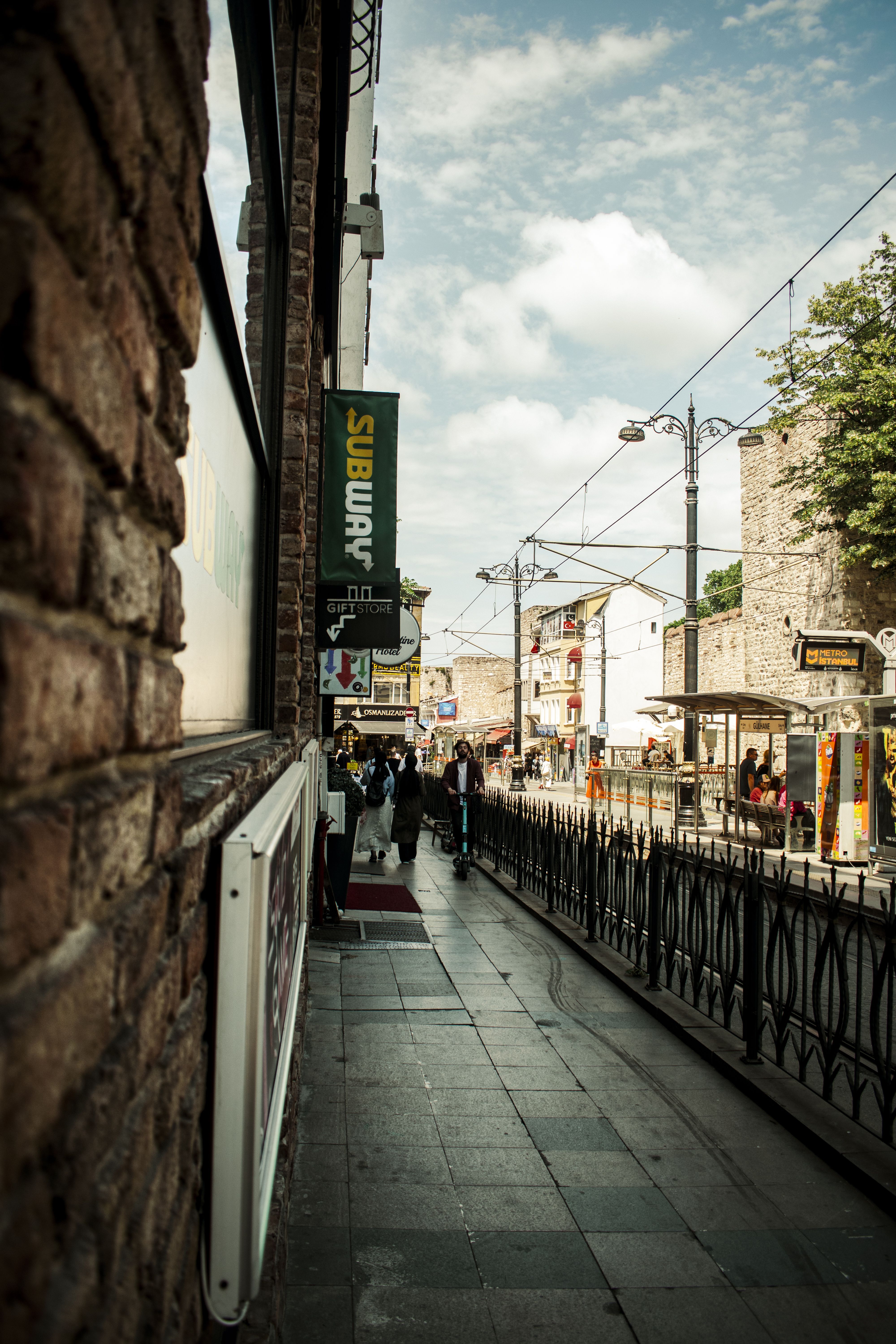 View of a Sidewalk, Building and a Bus Stop in City · Free Stock Photo