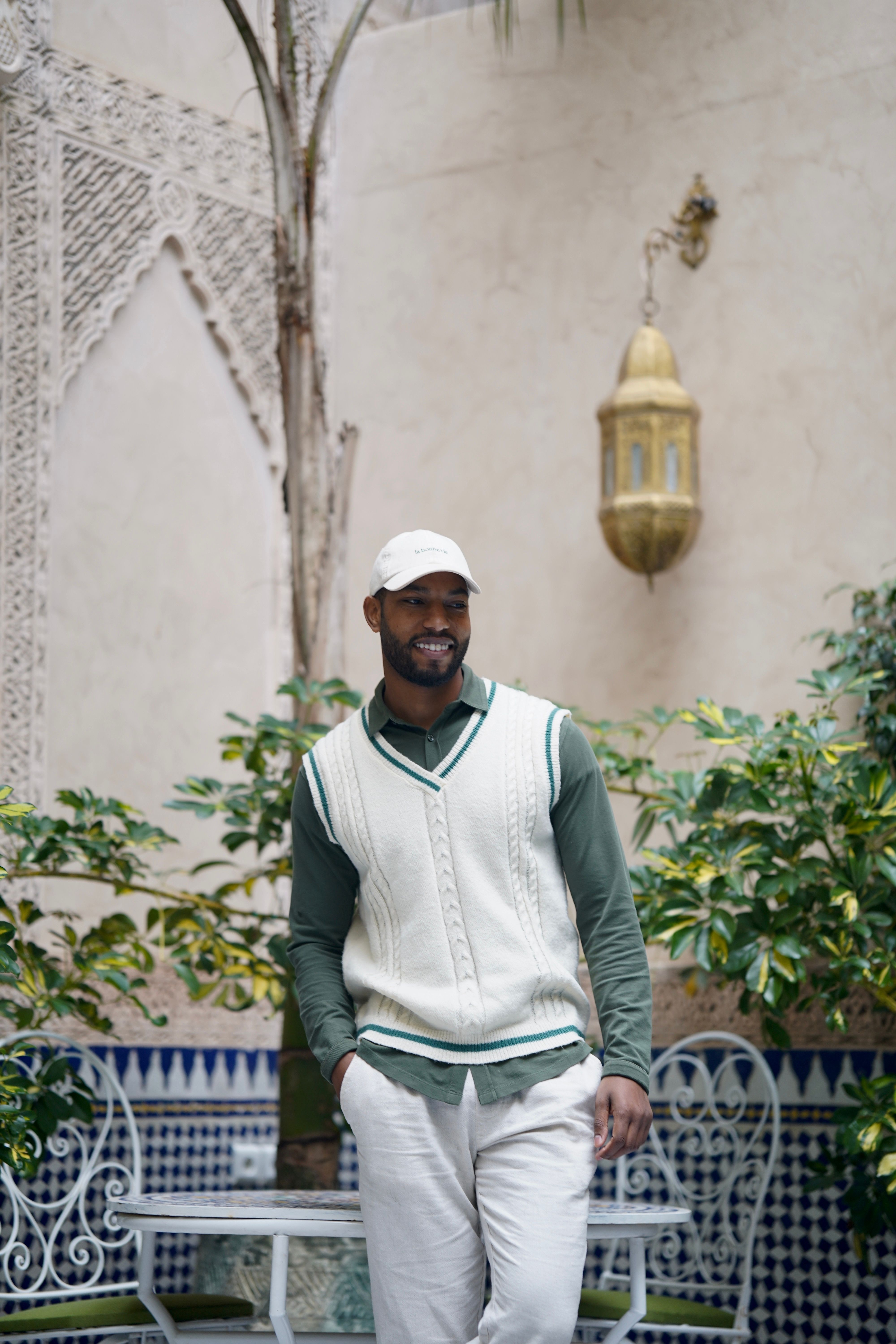 Male Model Wearing a Baseball Cap, a Vest and a Green Shirt · Free ...