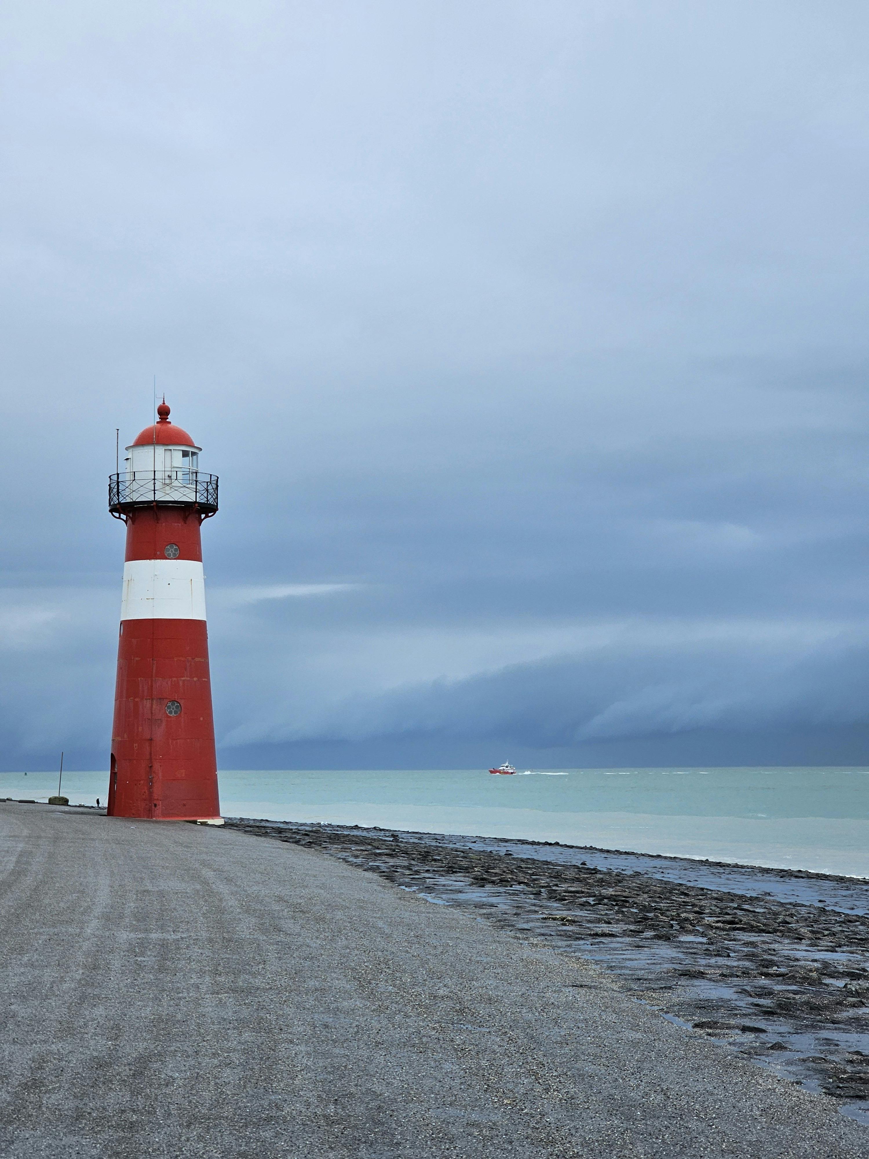 White Lighthouse Under Cloudy Sky · Free Stock Photo