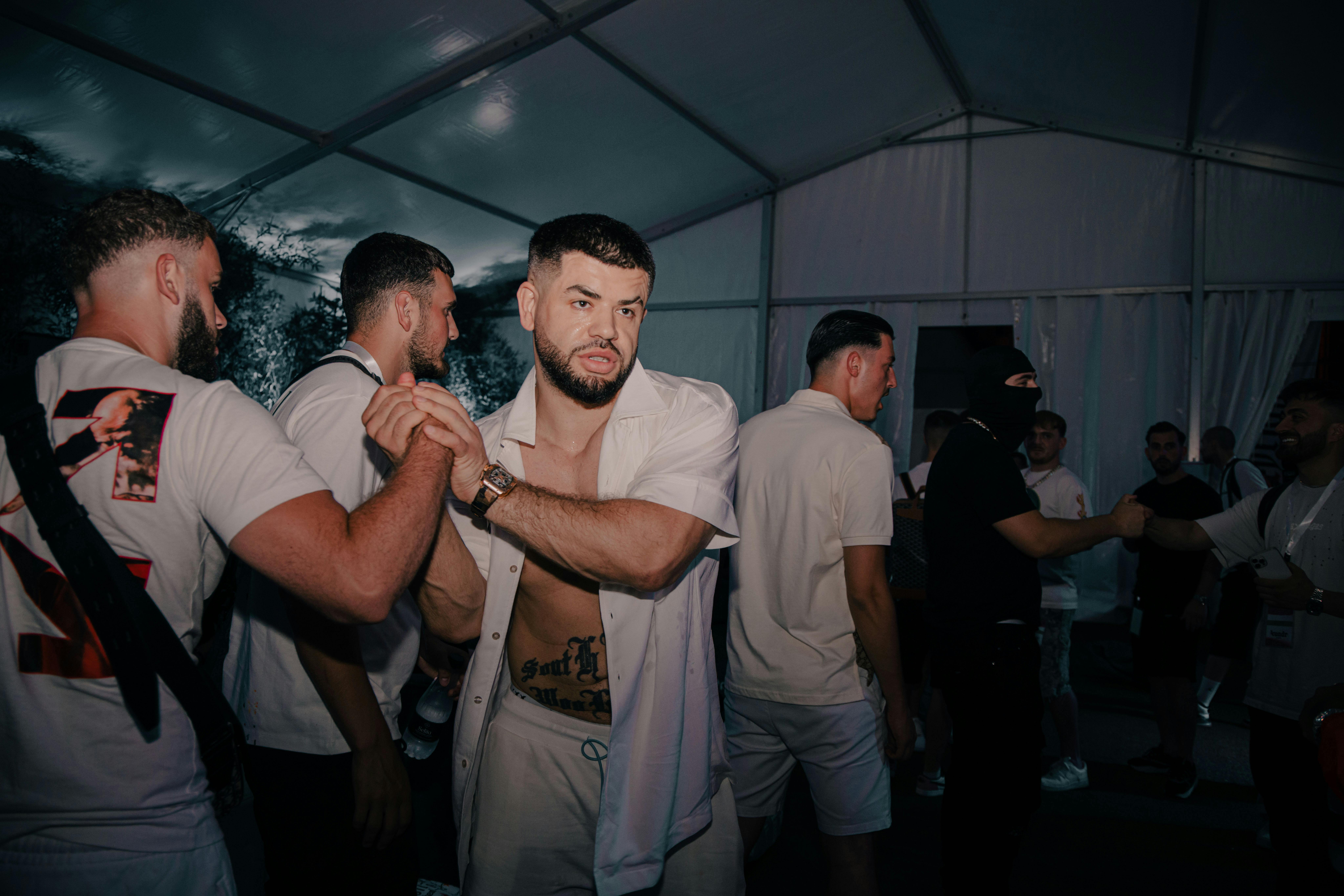 Muscular Men at a Tent During an Event · Free Stock Photo