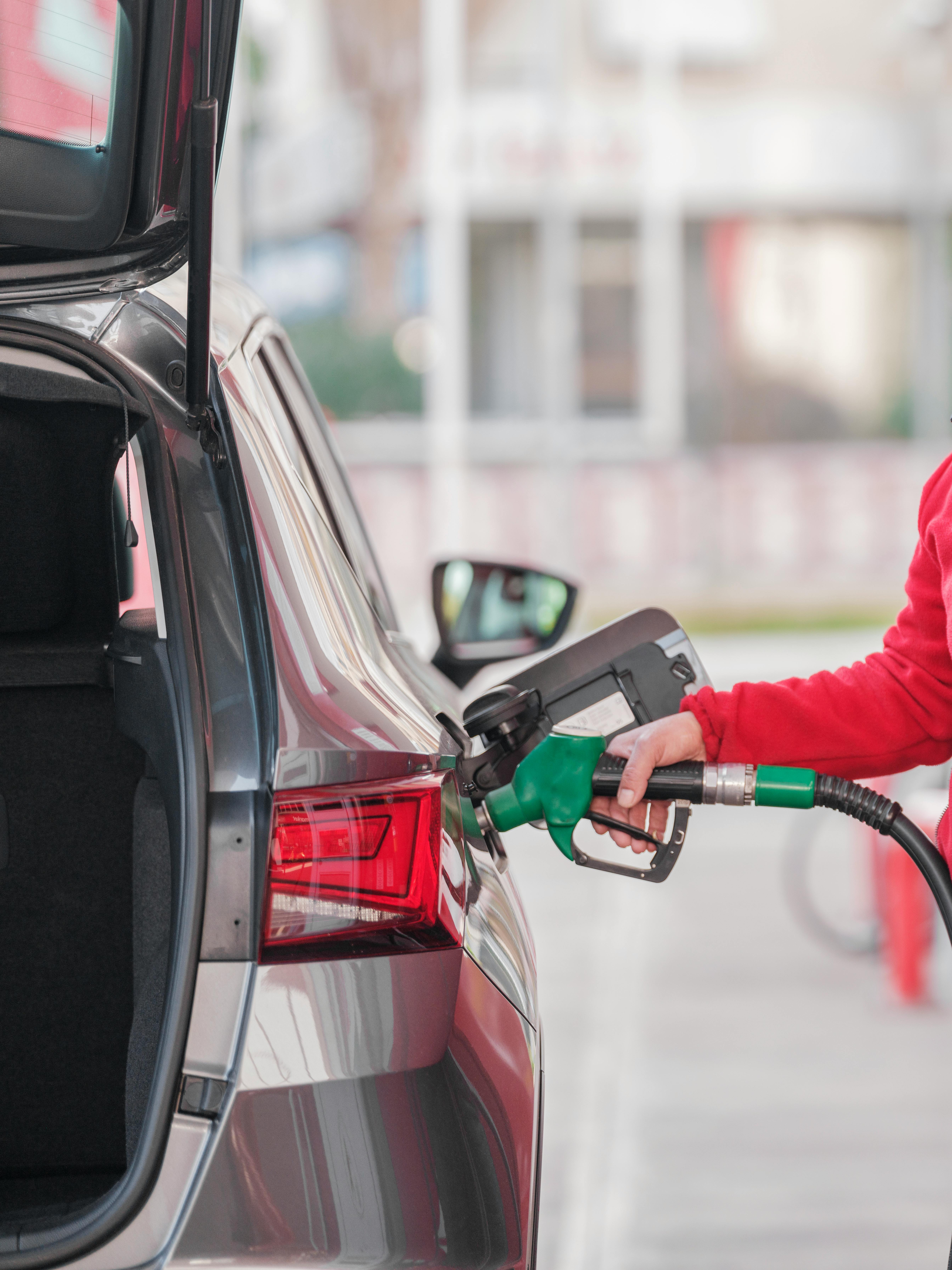 Close-up of a Person Refueling the Car at a Gas Station · Free Stock Photo
