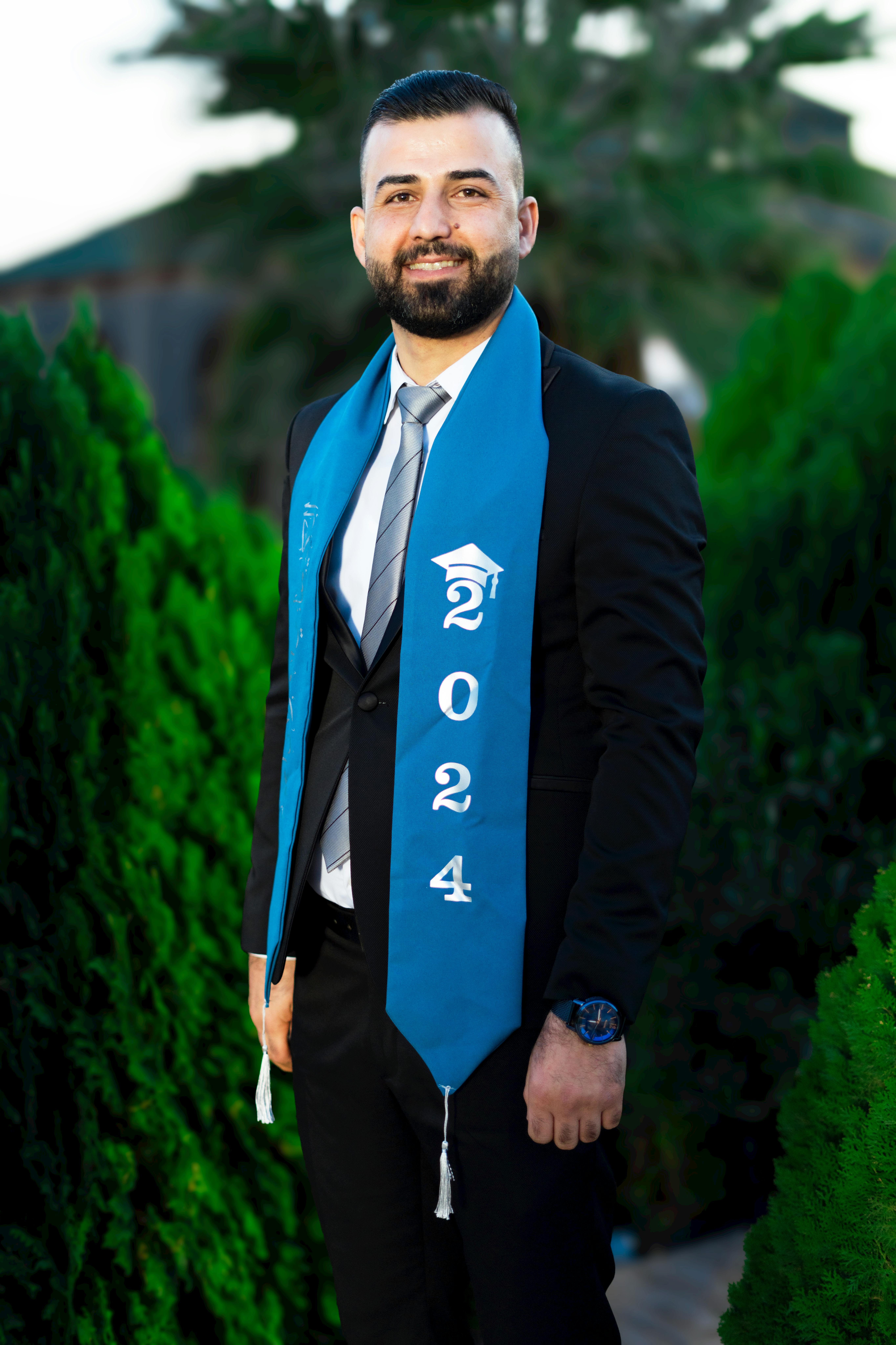 Portrait of Smiling Graduate in Scarf and Suit · Free Stock Photo