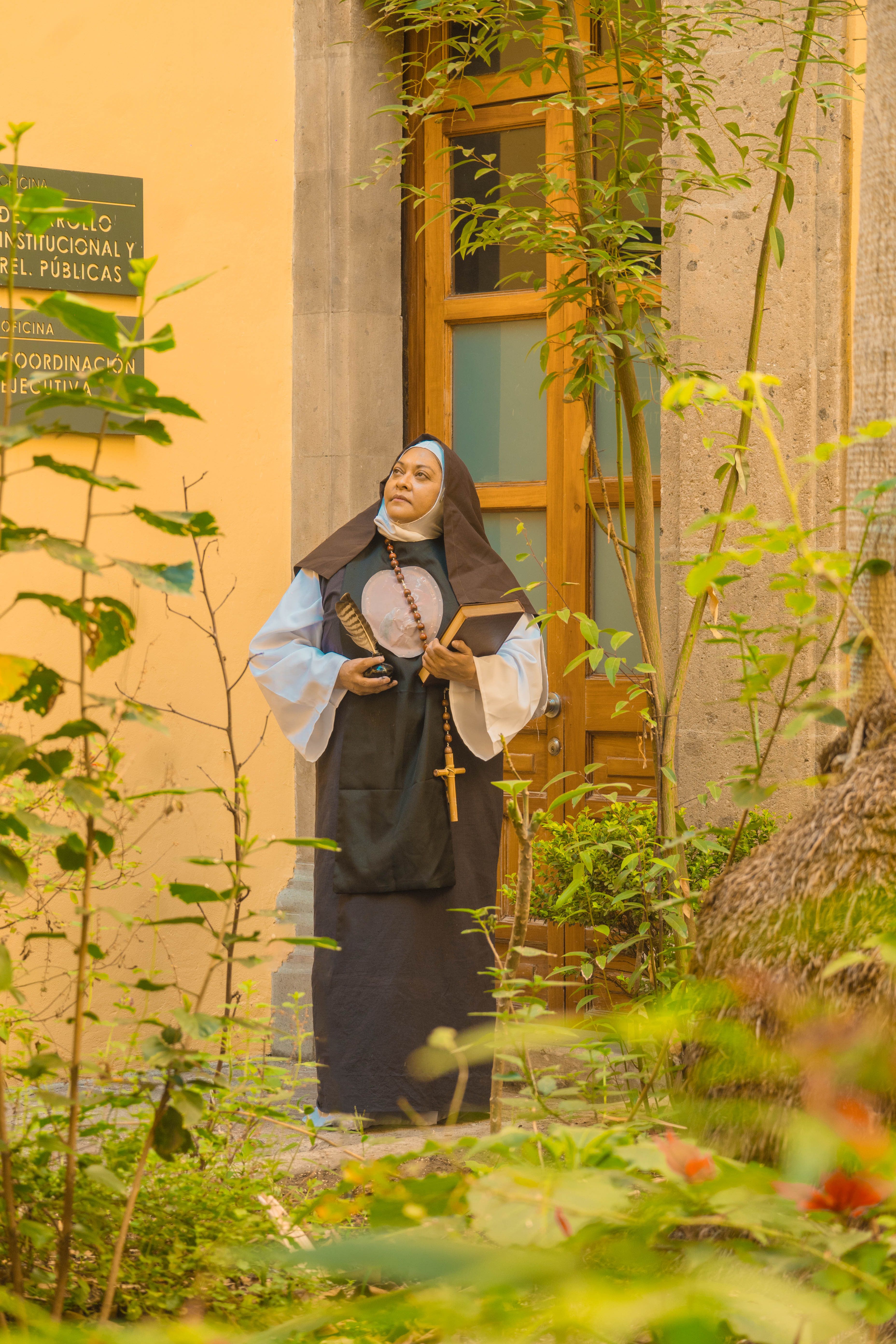 Nun Standing near Building Door · Free Stock Photo