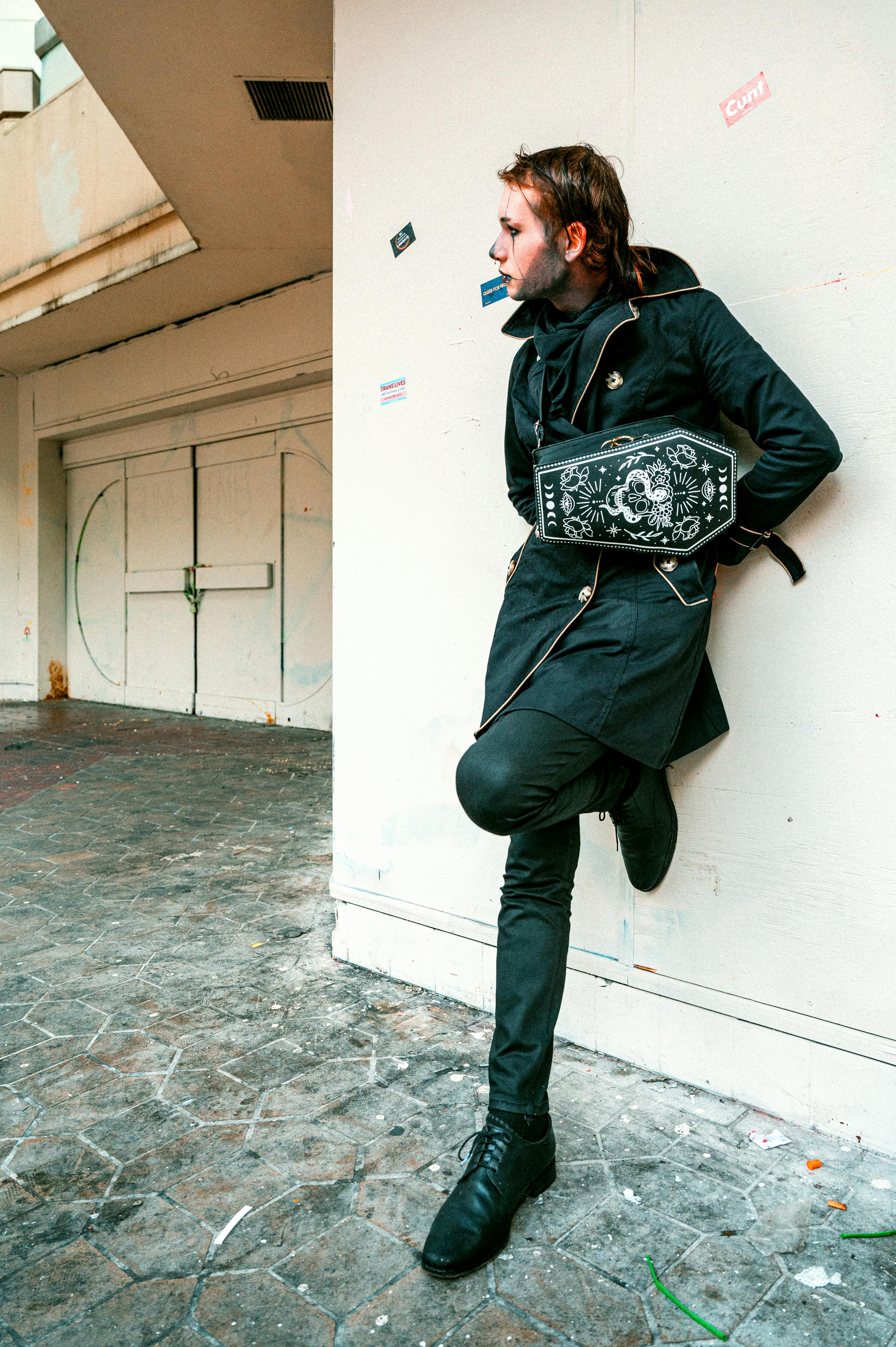Man Dressed in Punk Style Leaning Against a Wall · Free Stock Photo