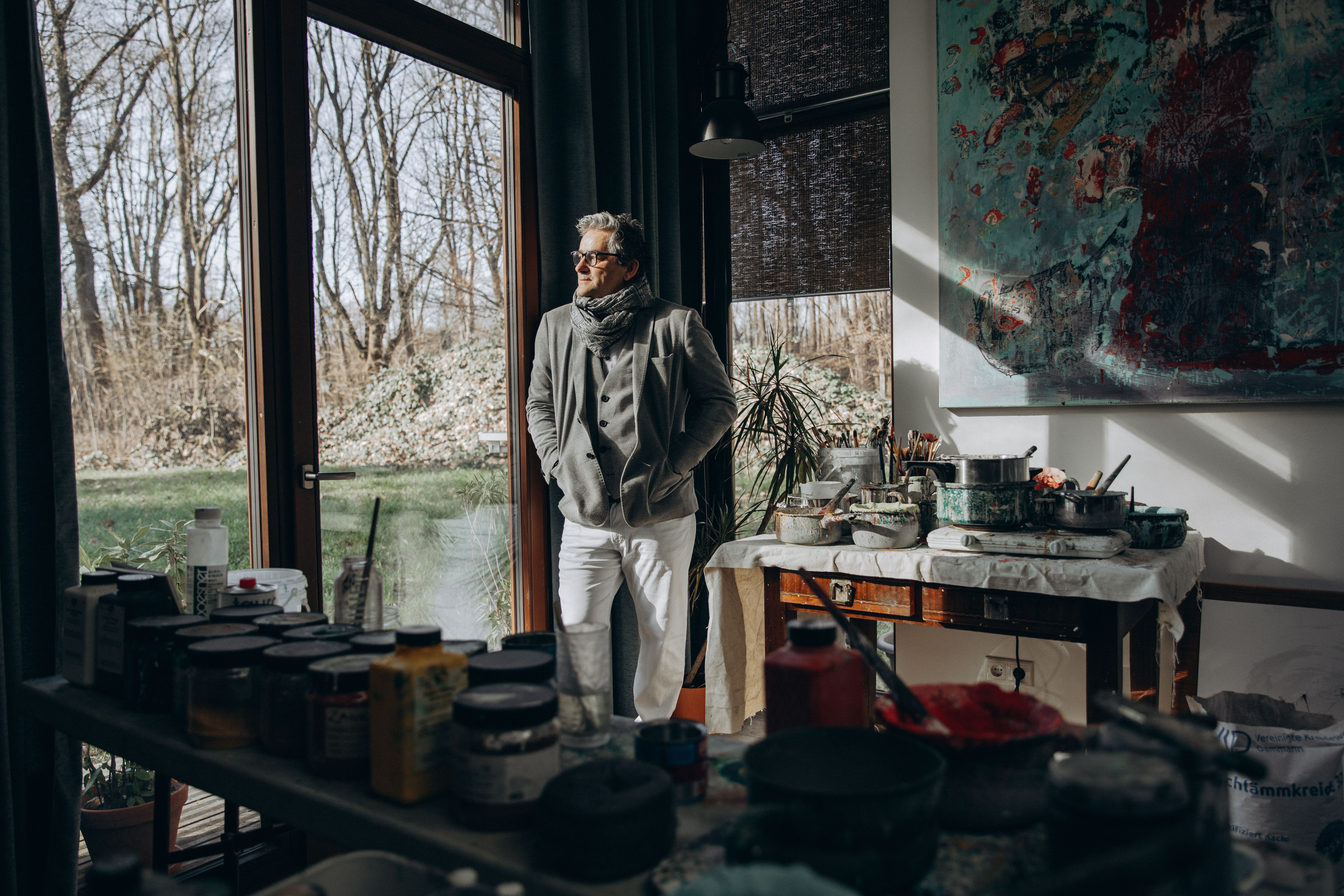 An Artist Standing by the Window in an Art Studio · Free Stock Photo