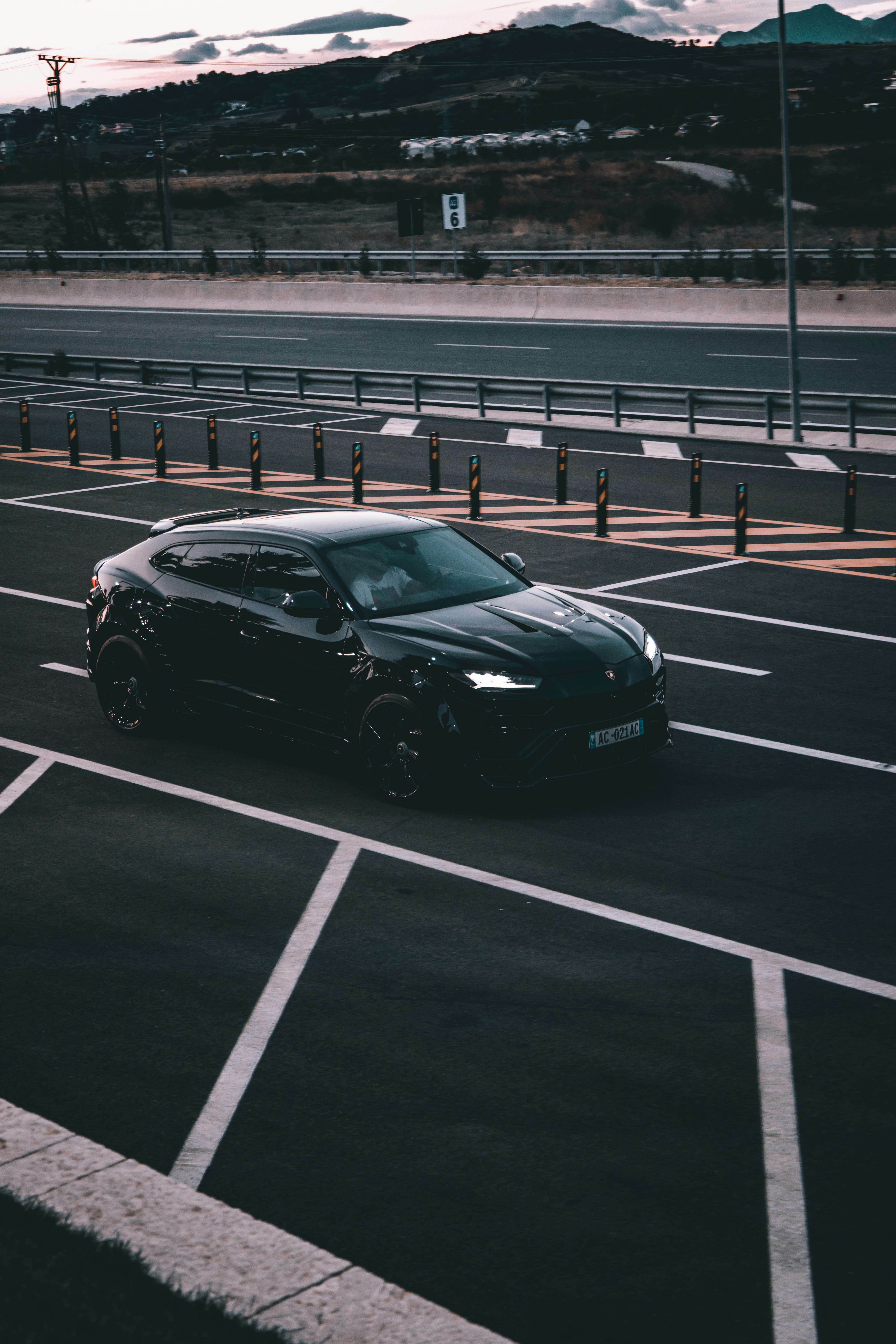 A Black Lamborghini Urus Driving on a Highway · Free Stock Photo