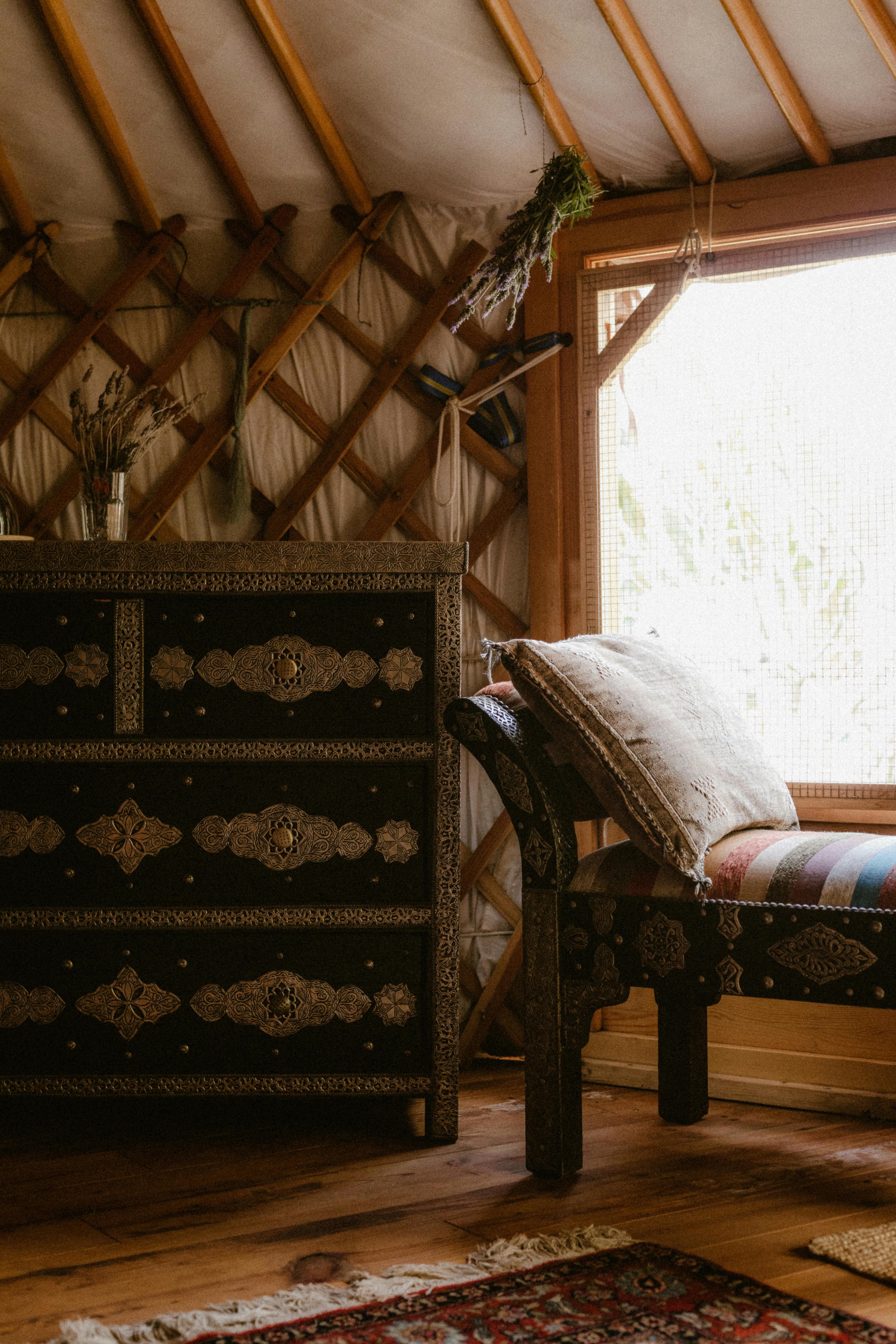A yurt with a wooden bench and a window · Free Stock Photo