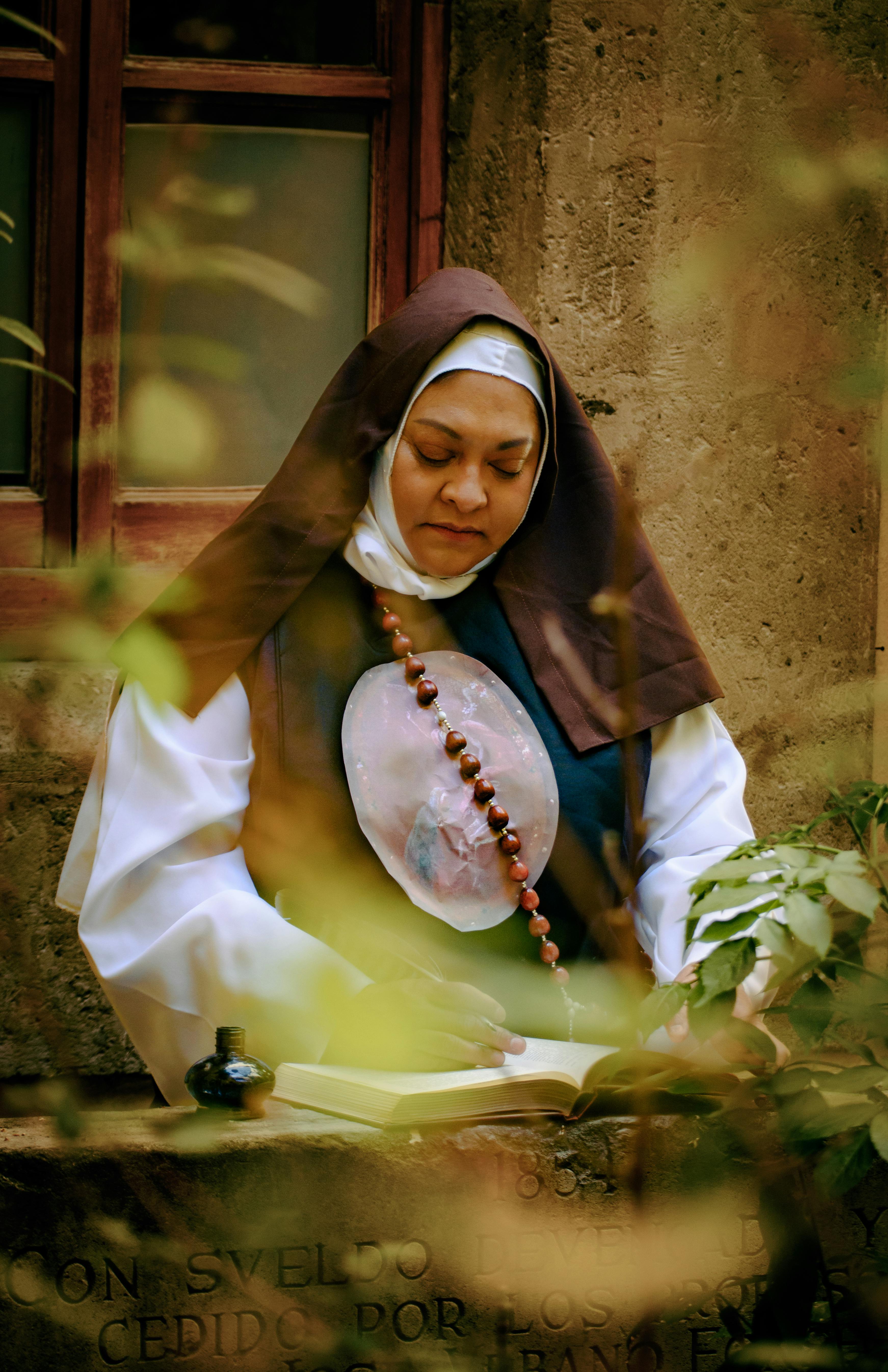 Nun Writing in a Book · Free Stock Photo