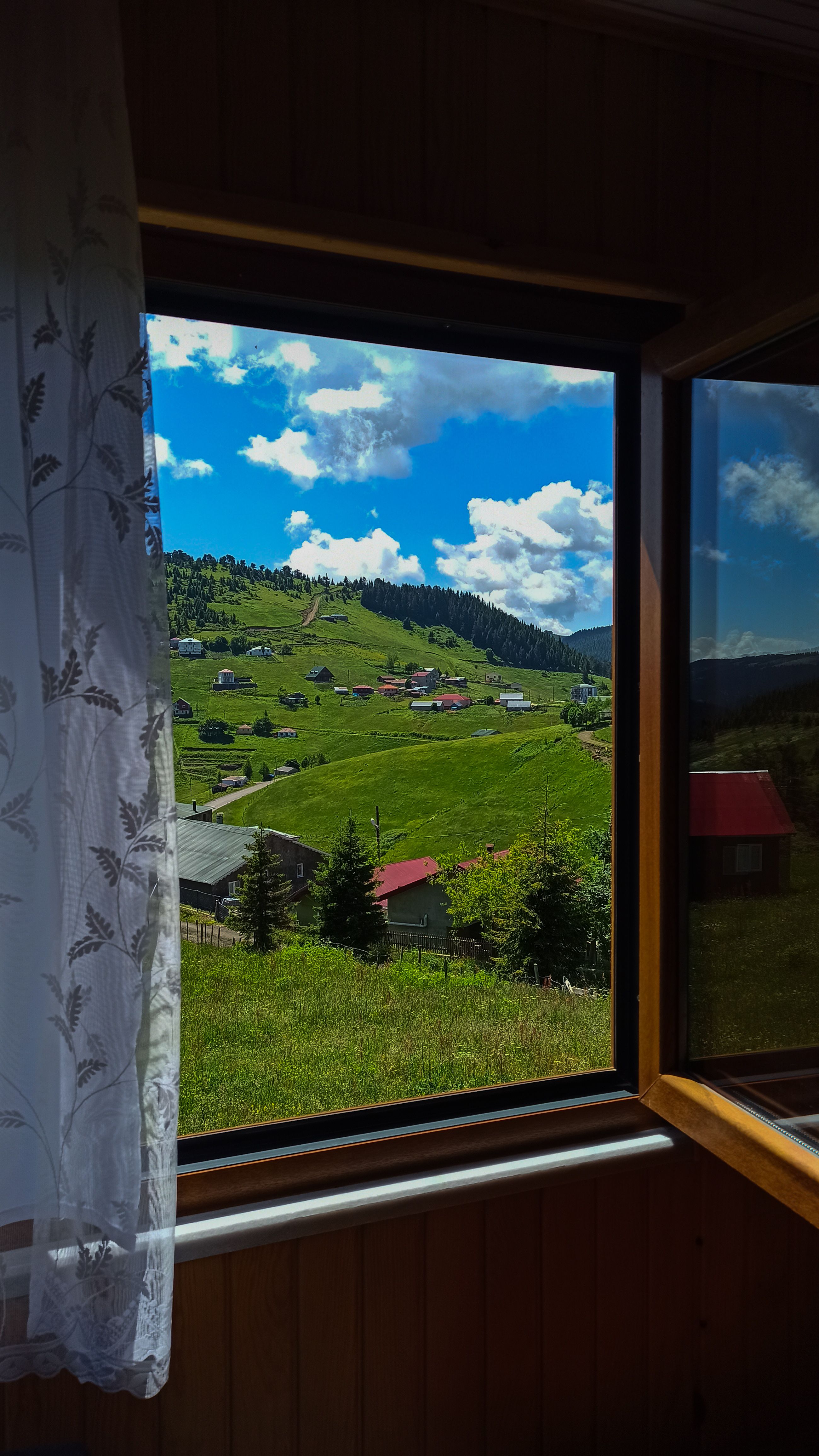 Buildings on a Field Seen From a Window · Free Stock Photo
