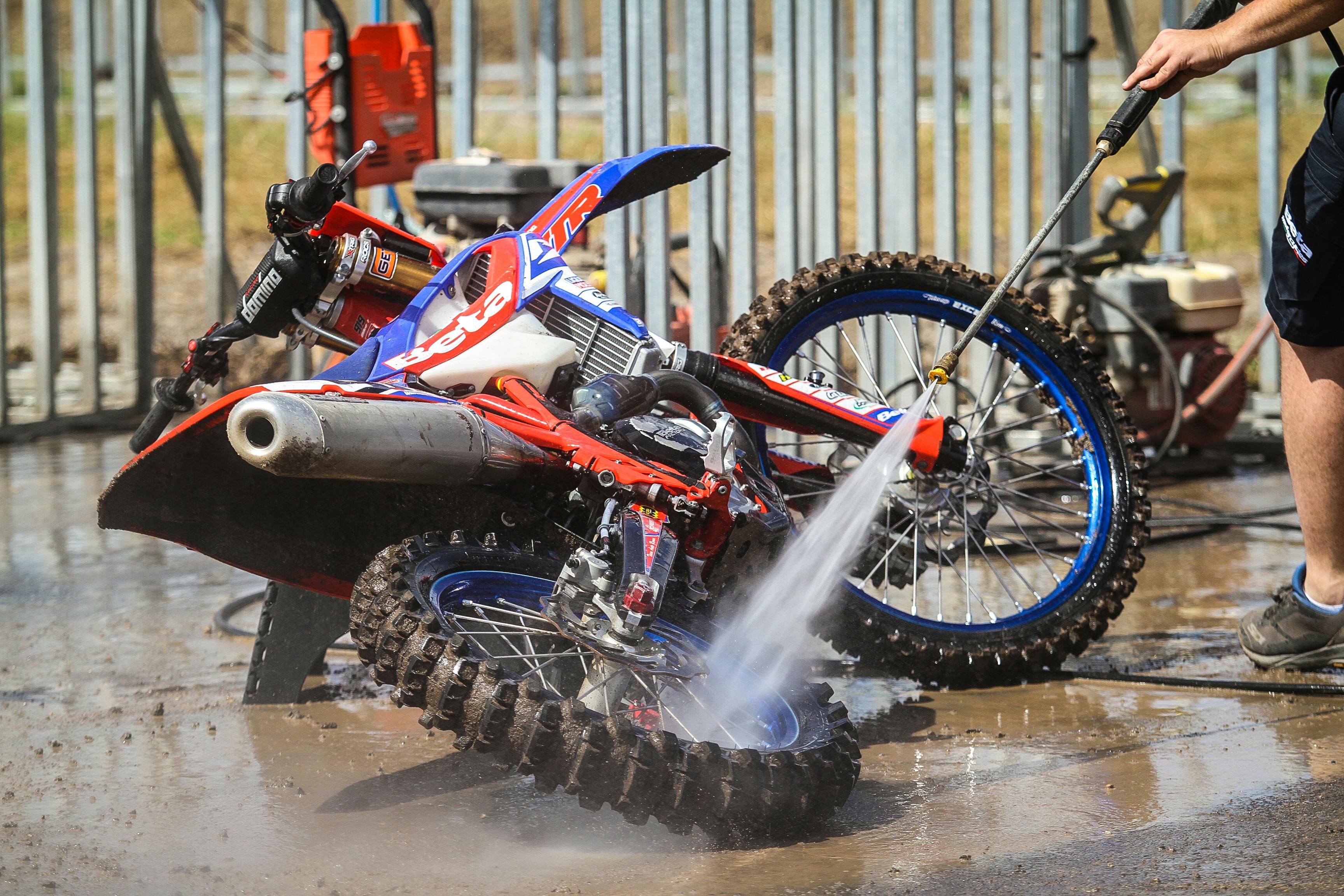 Person Washing a Motocross Motorcycle · Free Stock Photo