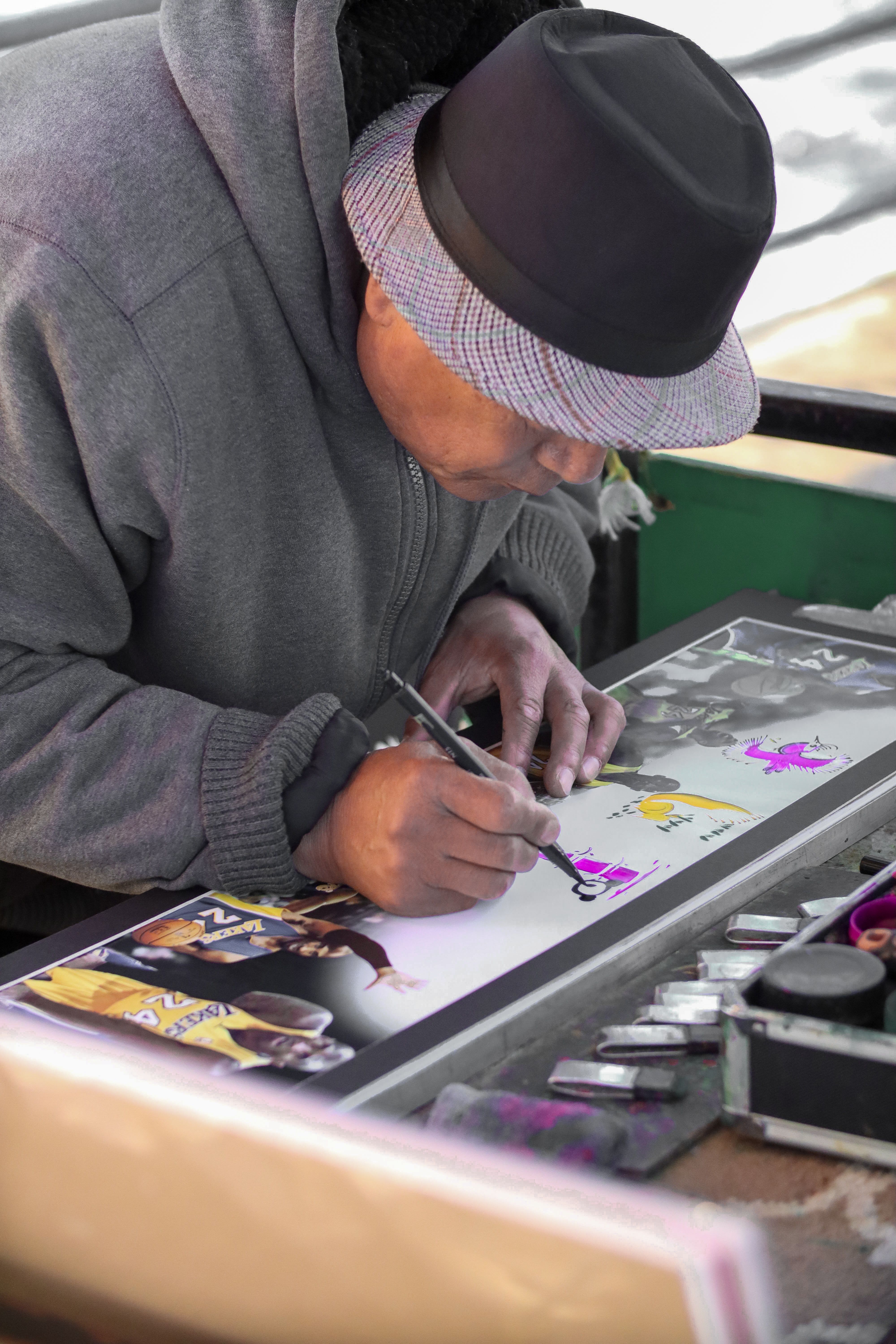 Graphic Designer Hand-decorating a Poster · meta.free_stock.photo