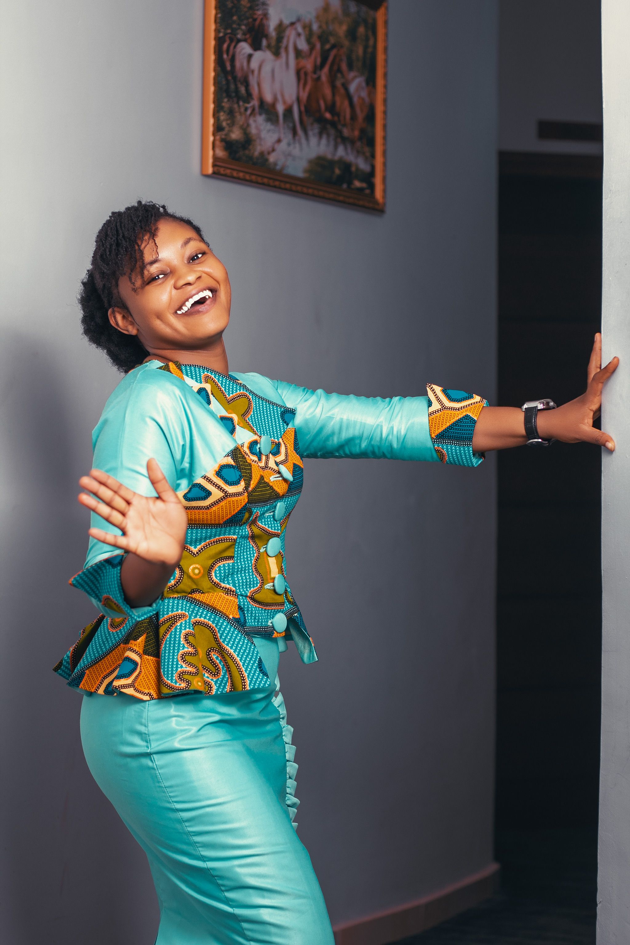 A woman in a turquoise outfit is smiling · Free Stock Photo