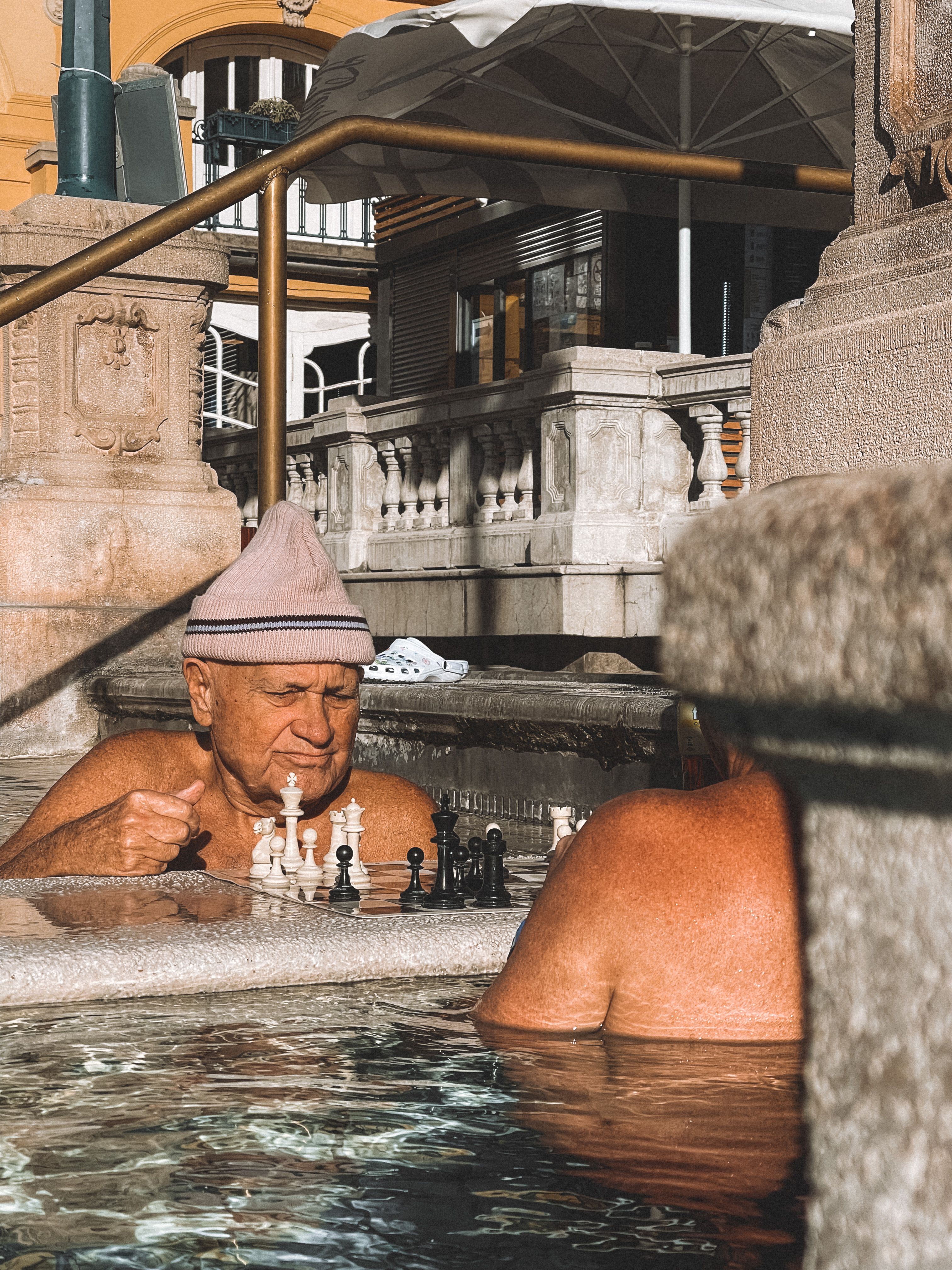 Elderly Men Playing Chess in Pool · Free Stock Photo