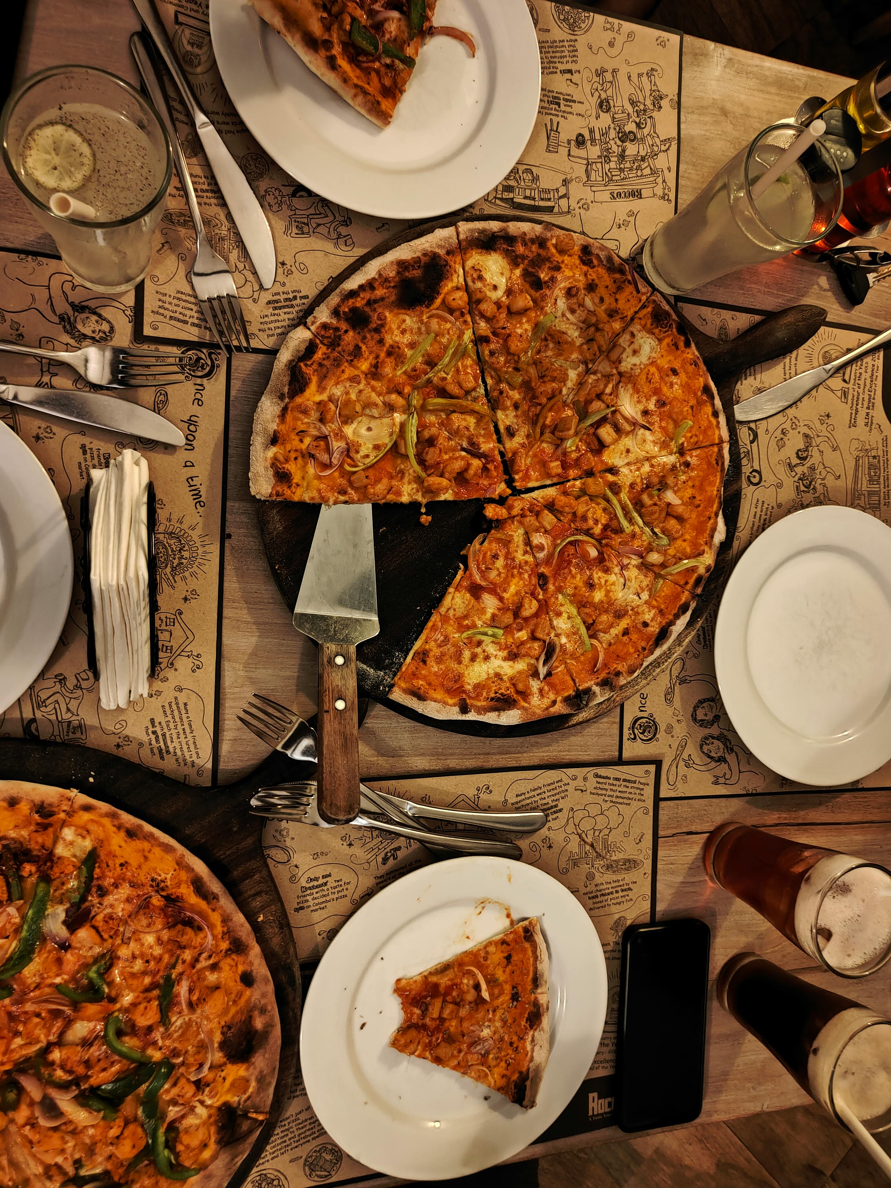 Sliced Pizza on a Table in a Restaurant · Free Stock Photo
