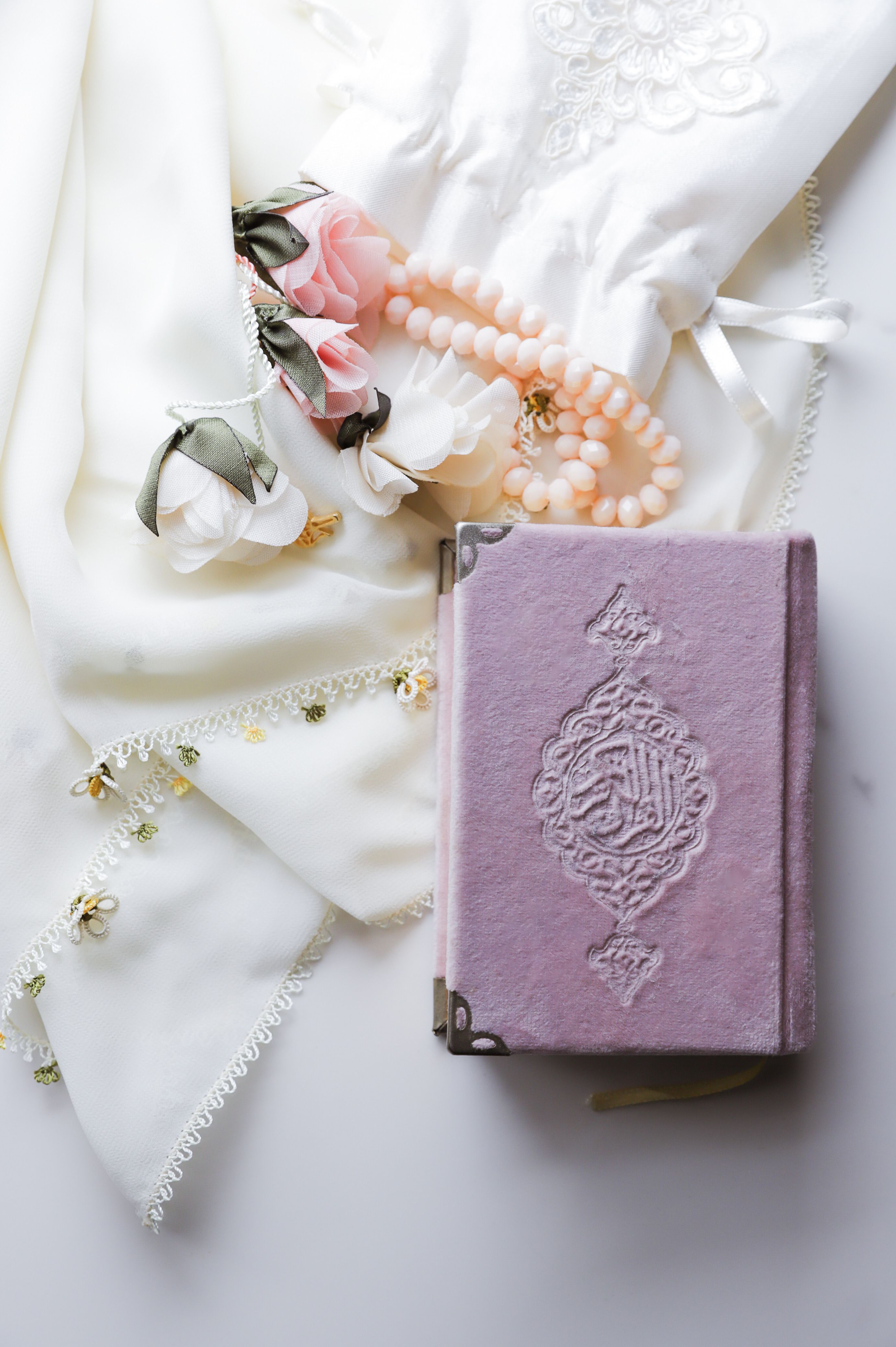 Pink Koran Book on a White Table · Free Stock Photo