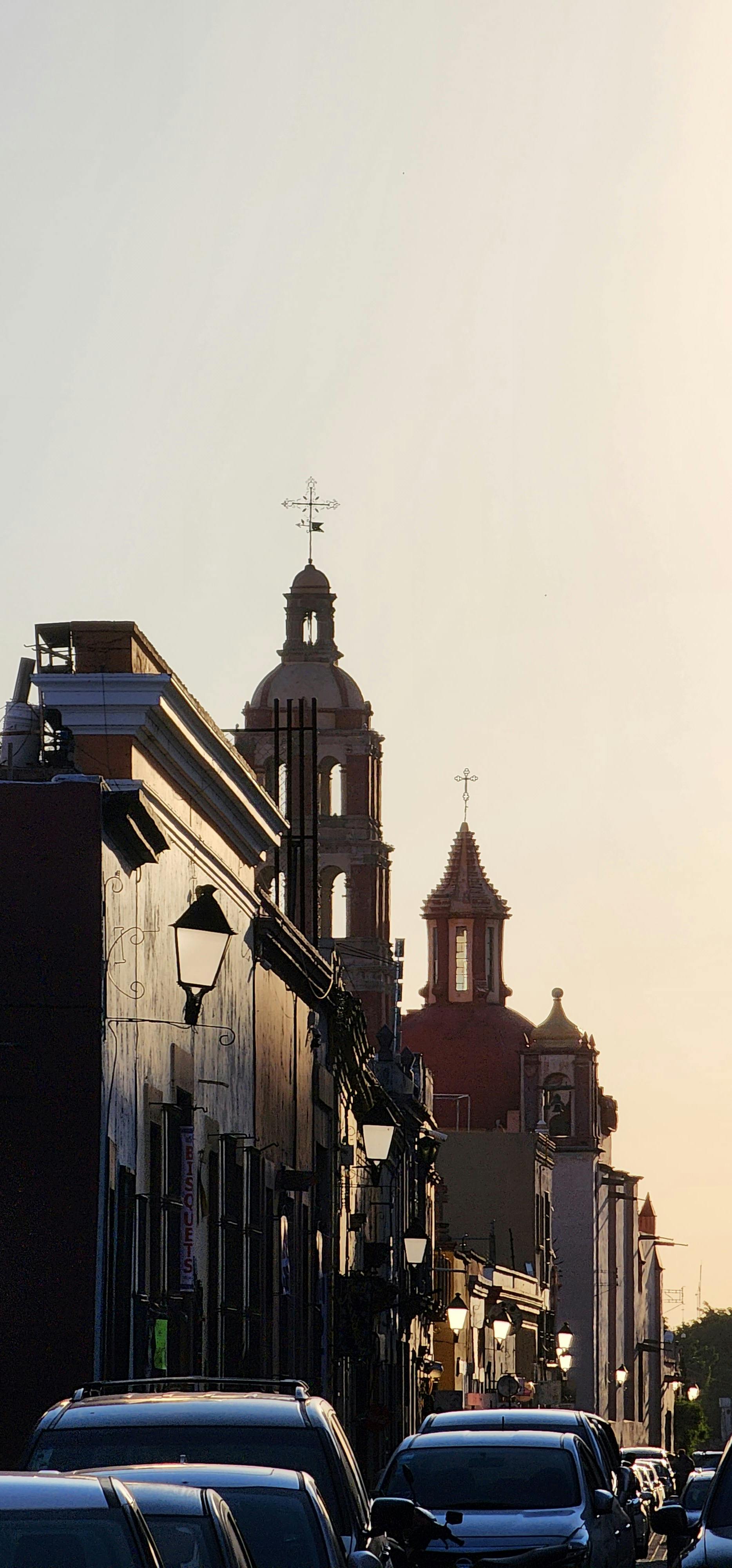 Church Towers over Street at Sunset · Free Stock Photo