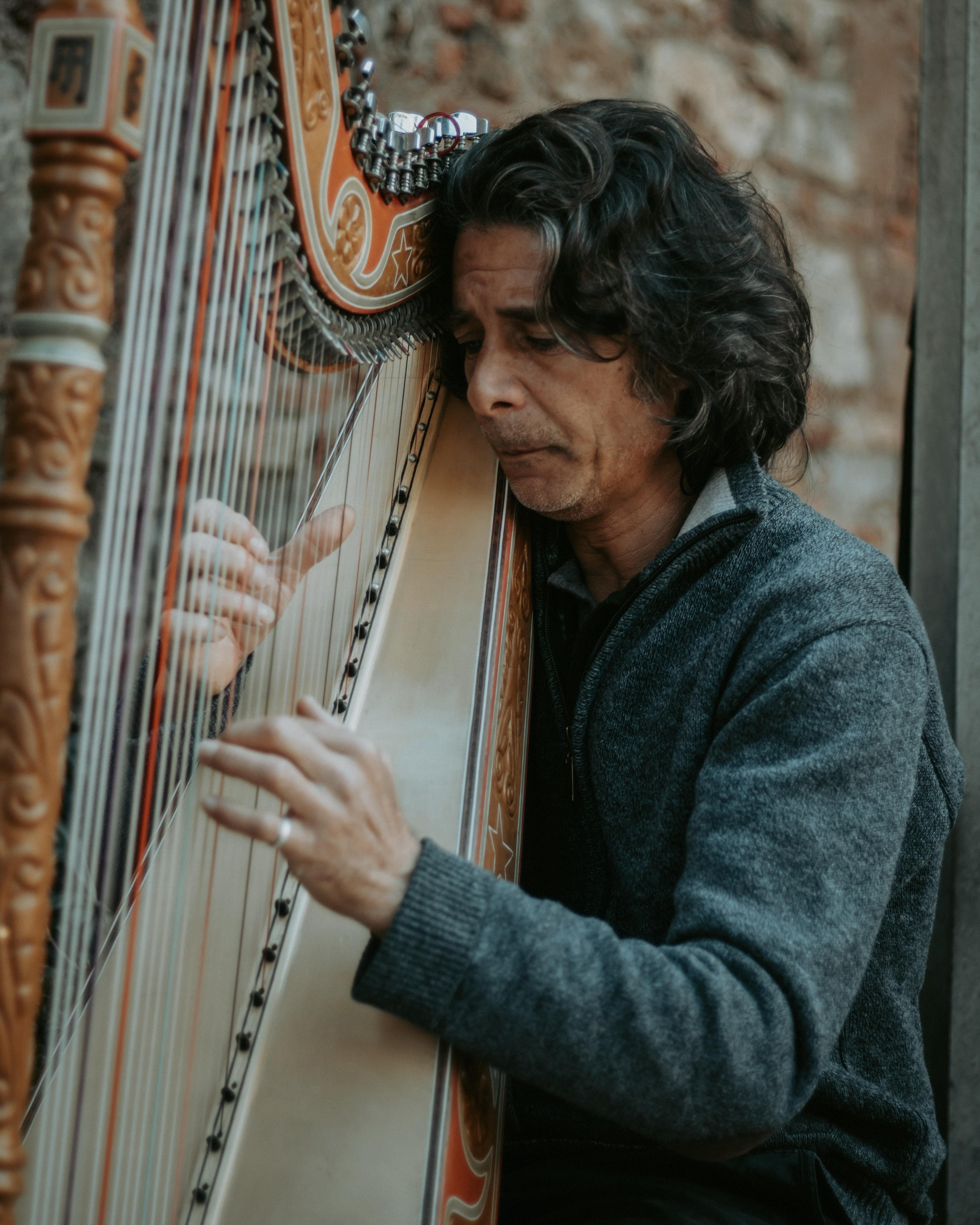 Portrait of Man Playing Harp · Free Stock Photo