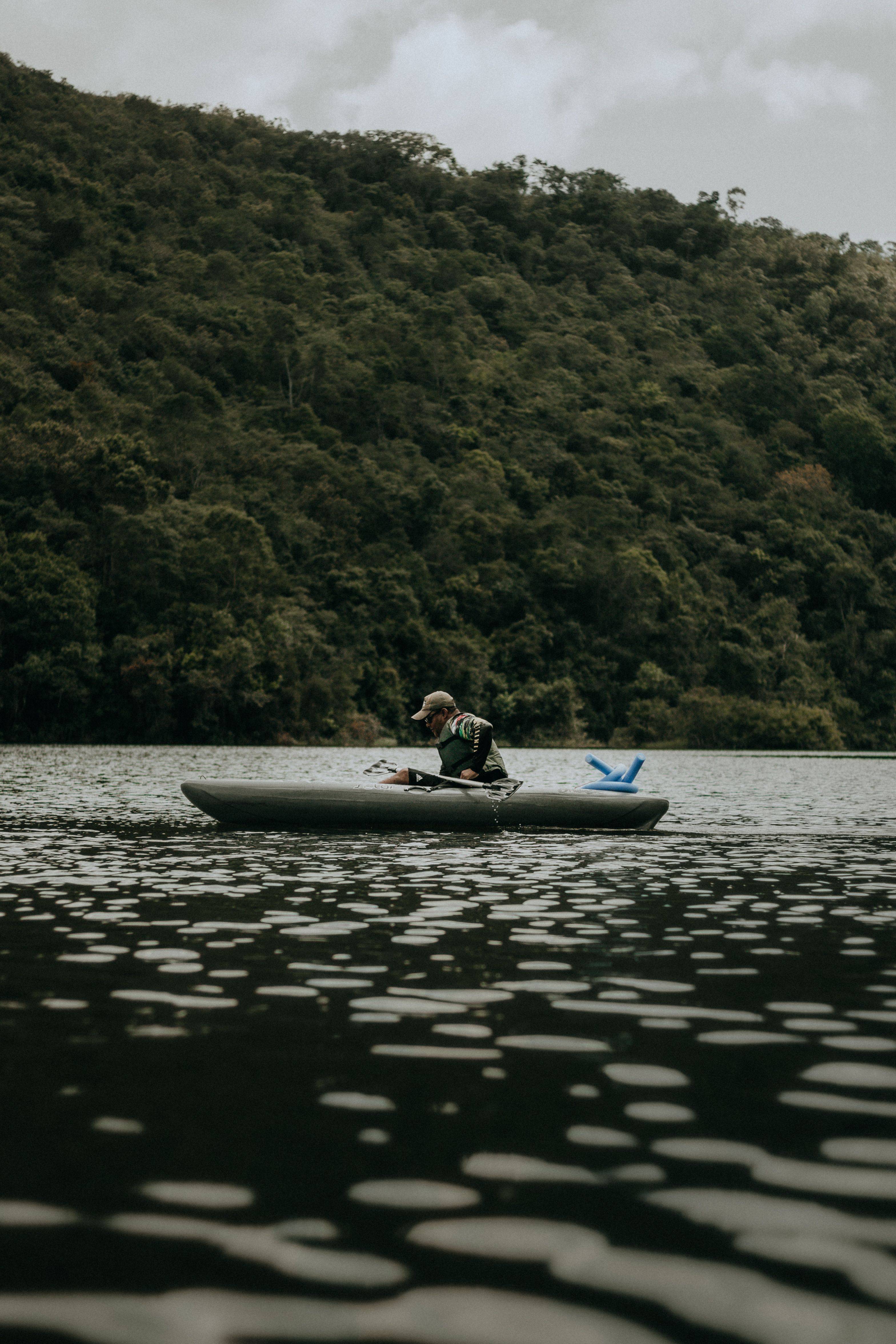 A Man Sitting in a Boat on a Body of Water · Free Stock Photo