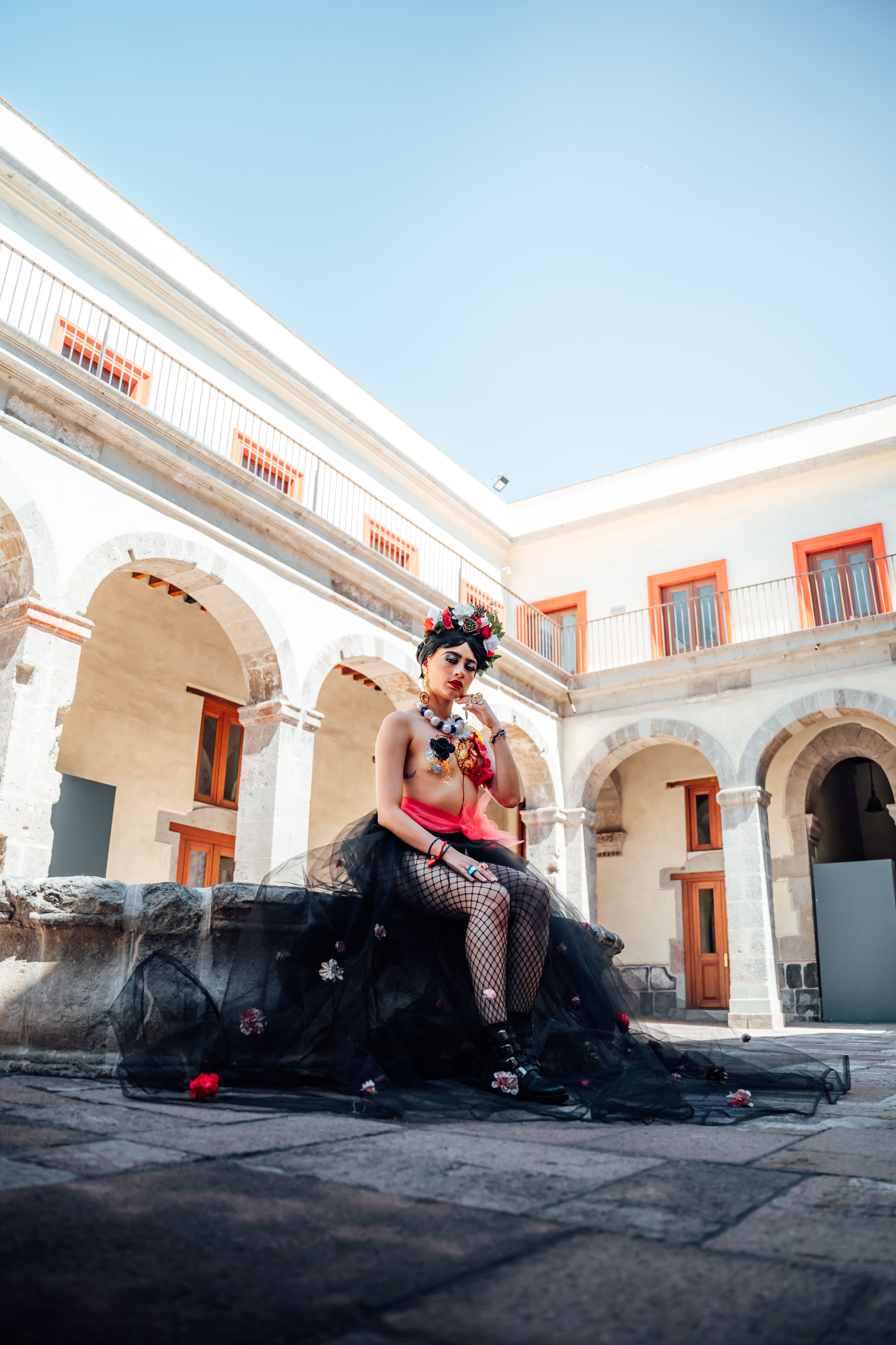 Young Person in a Dress with Flowers Posing in the Courtyard of a ...