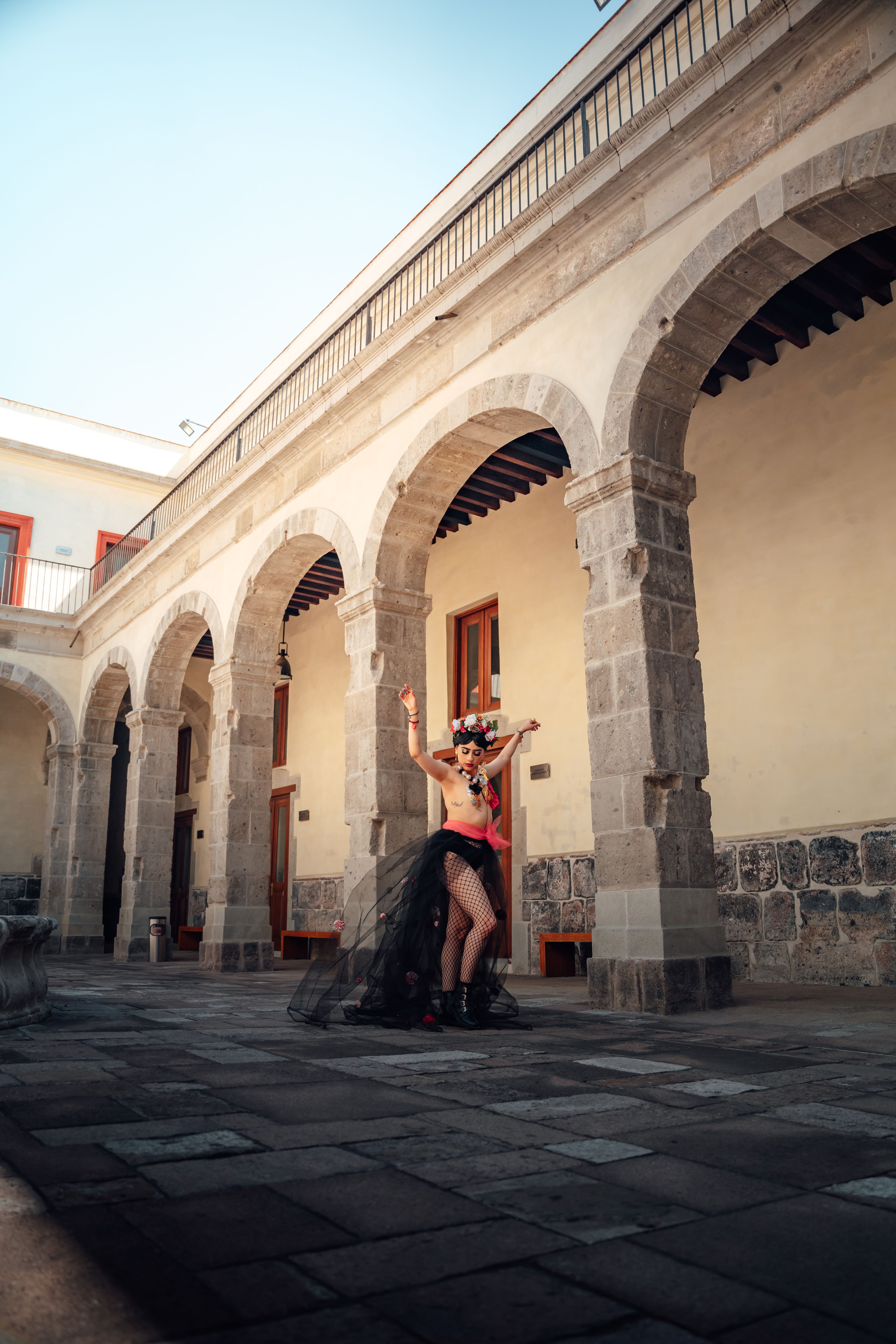 Woman in Tulle Dress Dancing under Archway · Free Stock Photo
